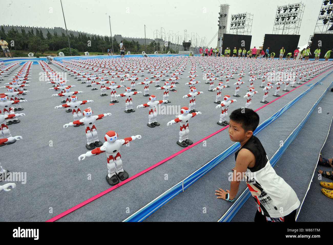 A young boy watches robots dancing during a challenge to set a new ...