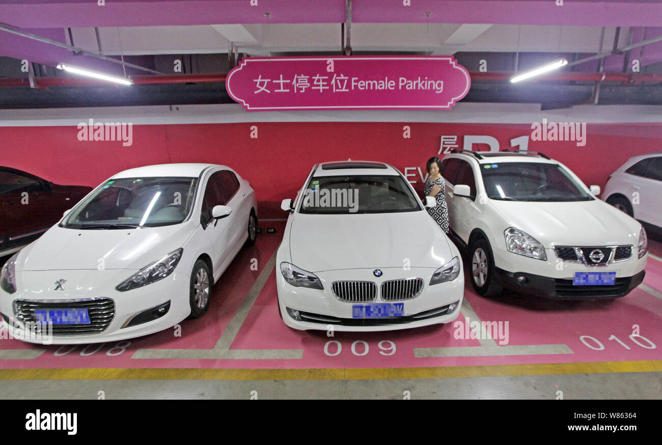 Cars are parked on the pink spaces for females in the underground ...