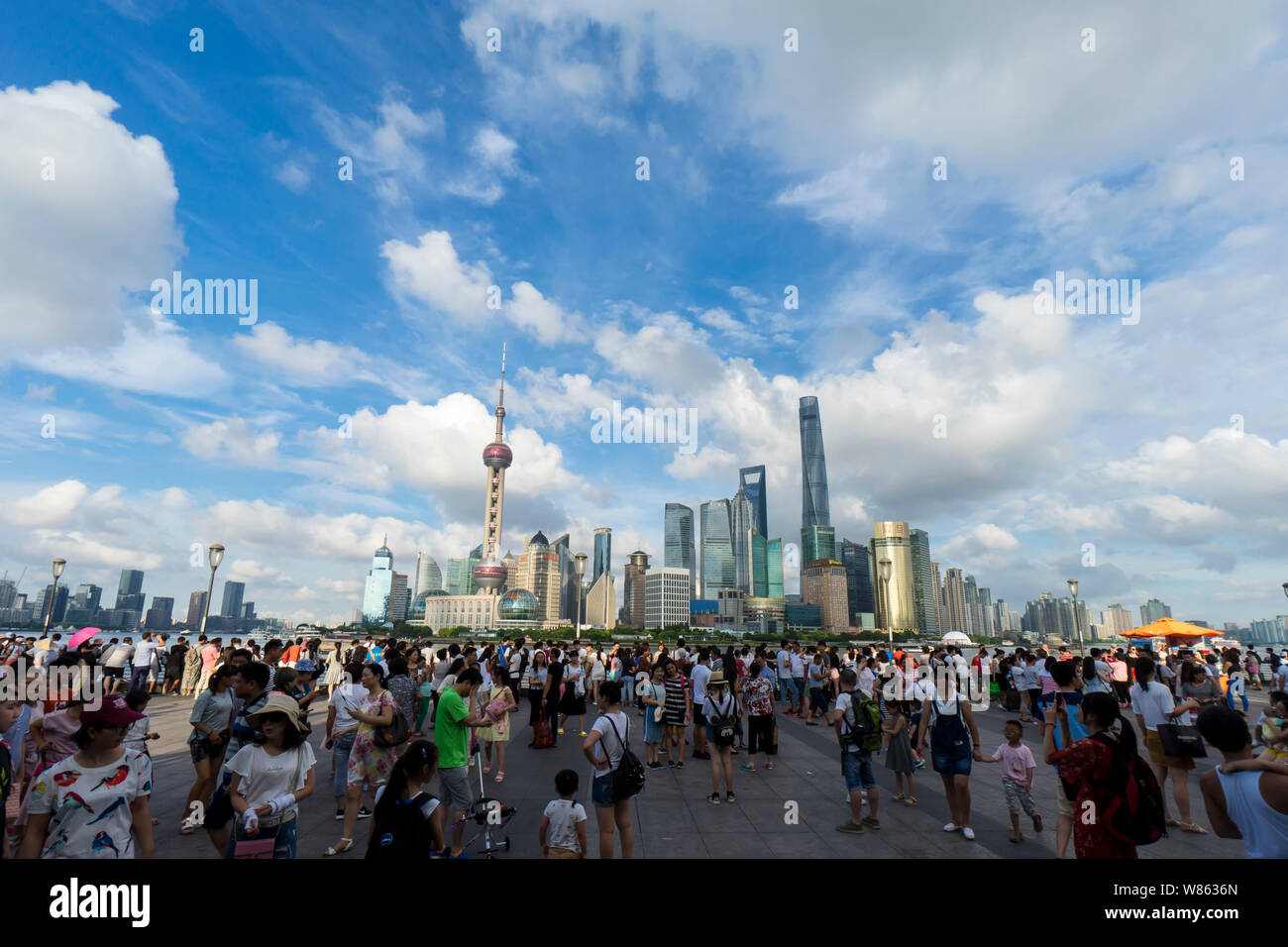 Tourists on the Bund look at skyline of the Lujiazui Financial District ...