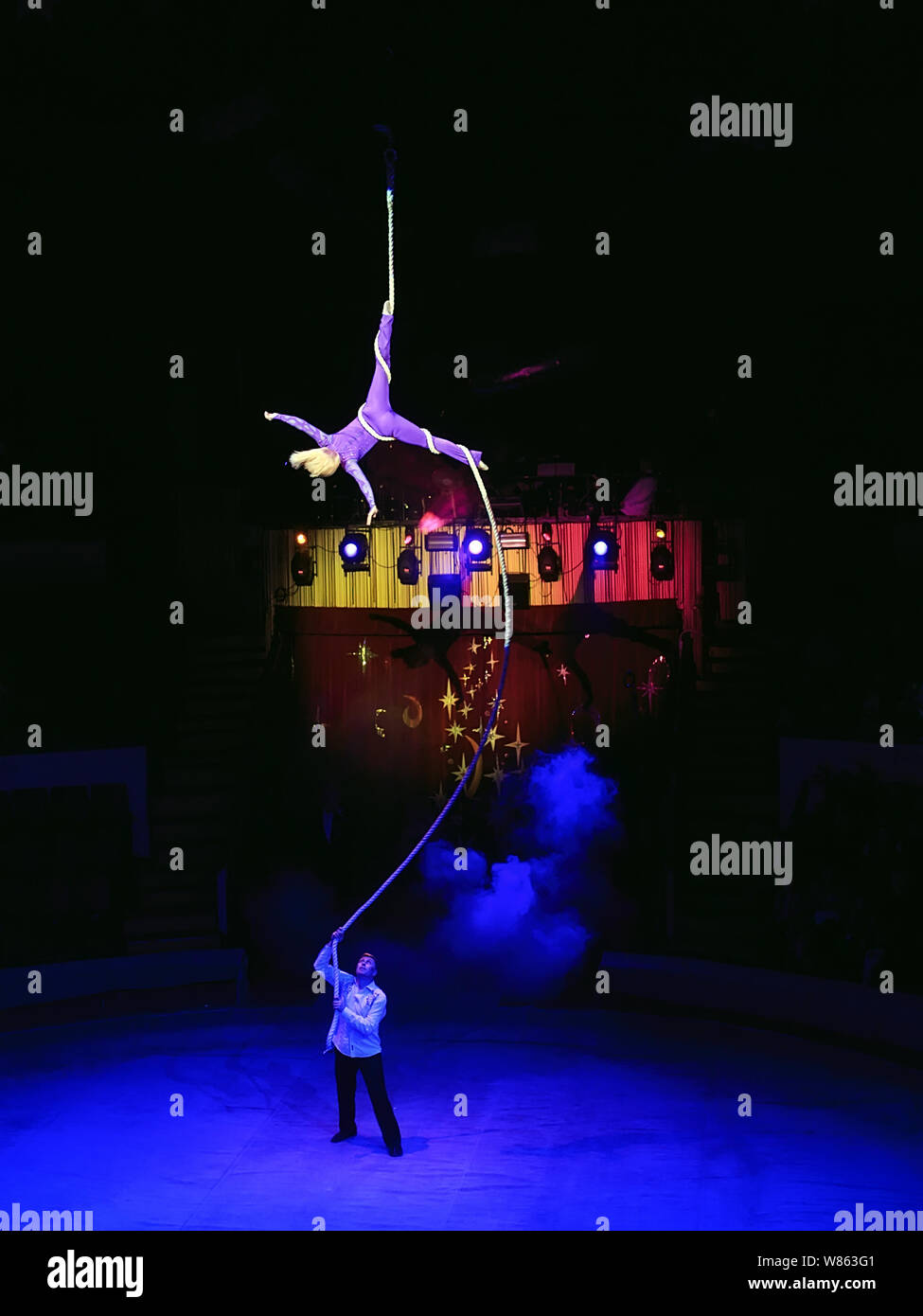 Aerial acrobat in the ring. A young girl performs the acrobatic ...