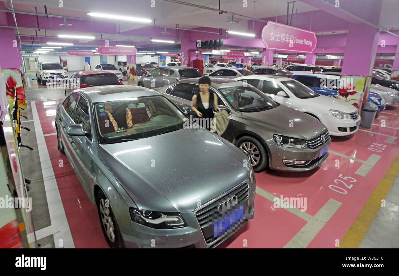 Cars are parked on the pink spaces for females in the underground ...