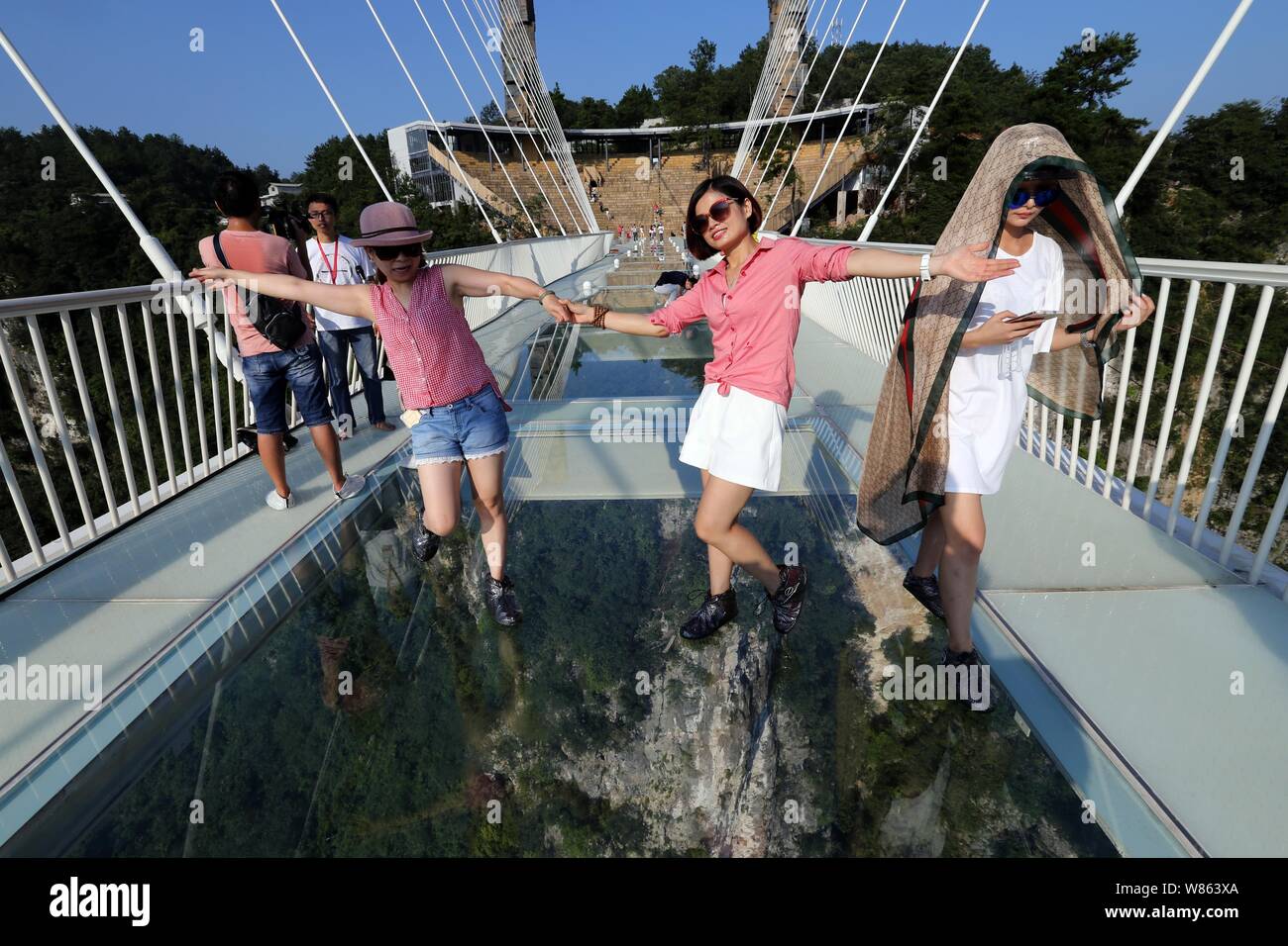 Tourists Pose On The Worlds Longest And Highest Glass Bottomed Bridge