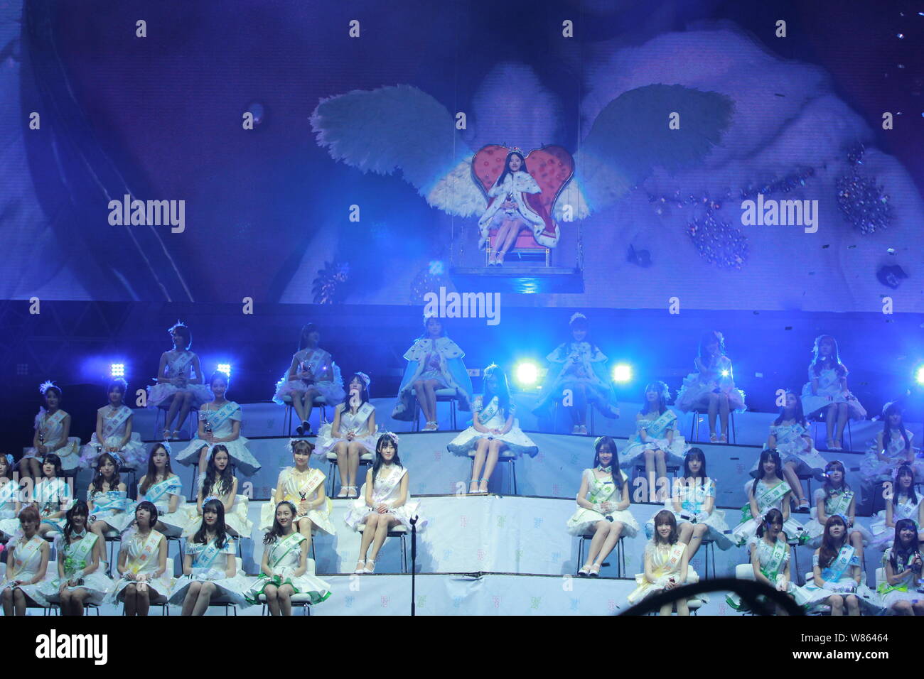 Winner Ju Jingyi of Chinese girl group SNH48 sitting on the champion ...