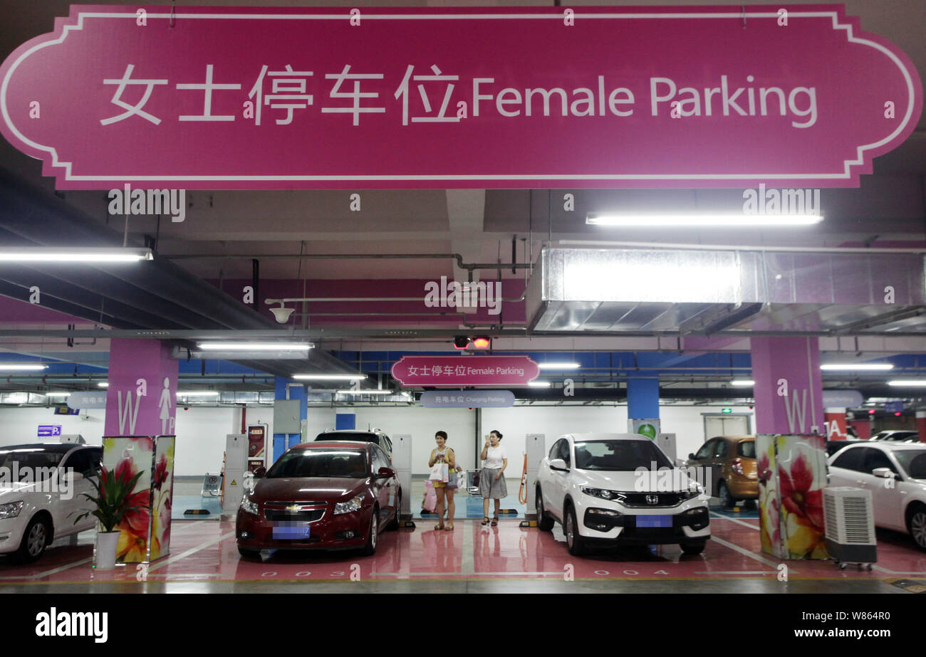 Cars are parked on the pink spaces for females in the underground ...
