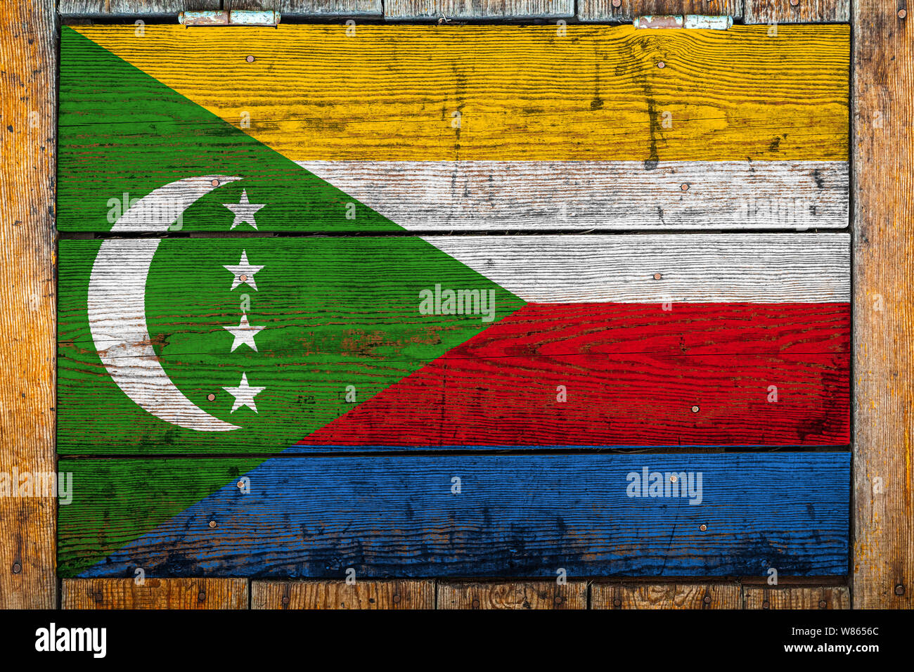 National flag of Comoros on a wooden wall background.The concept of ...