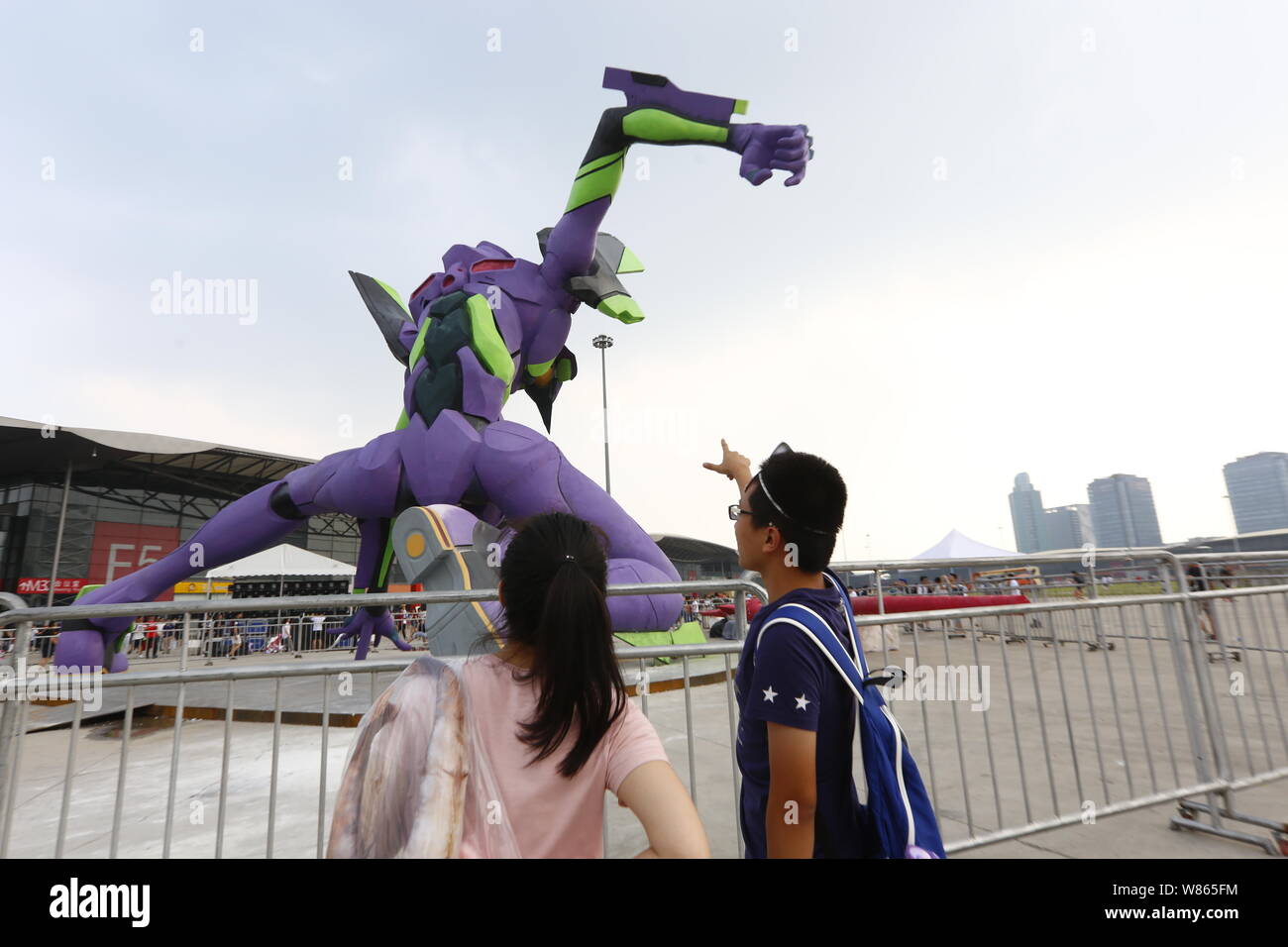 Visitors look at a giant model of Evangelion from Japanese animated ...