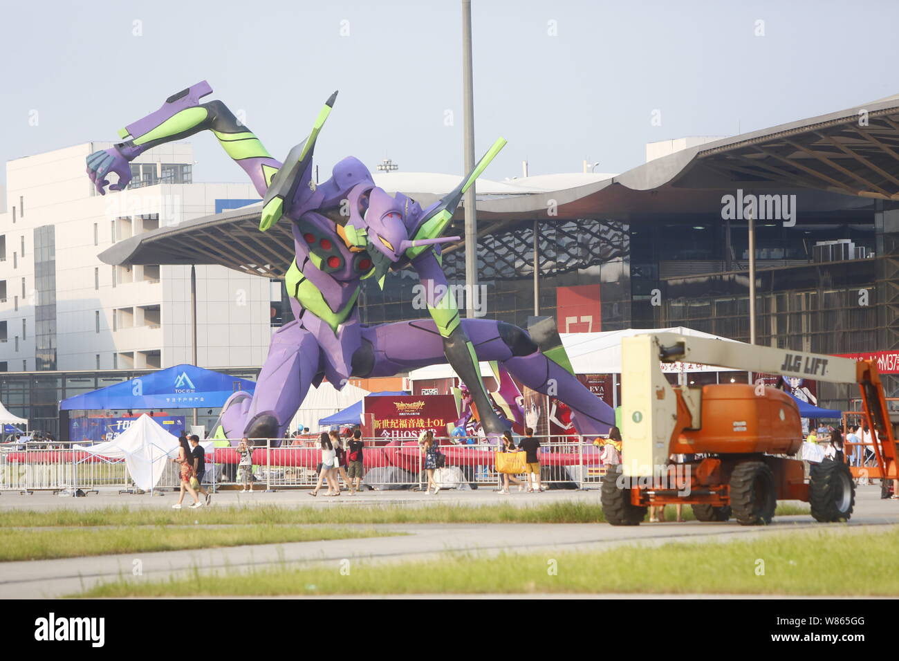 Visitors walk past a giant model of Evangelion from Japanese animated ...