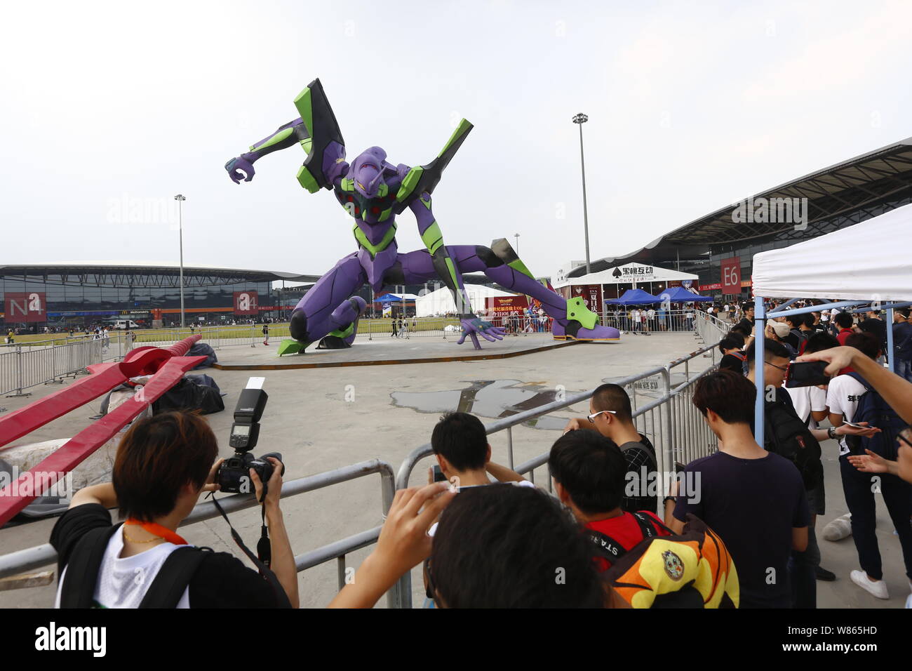Visitors take pictures of a giant model of Evangelion from Japanese ...