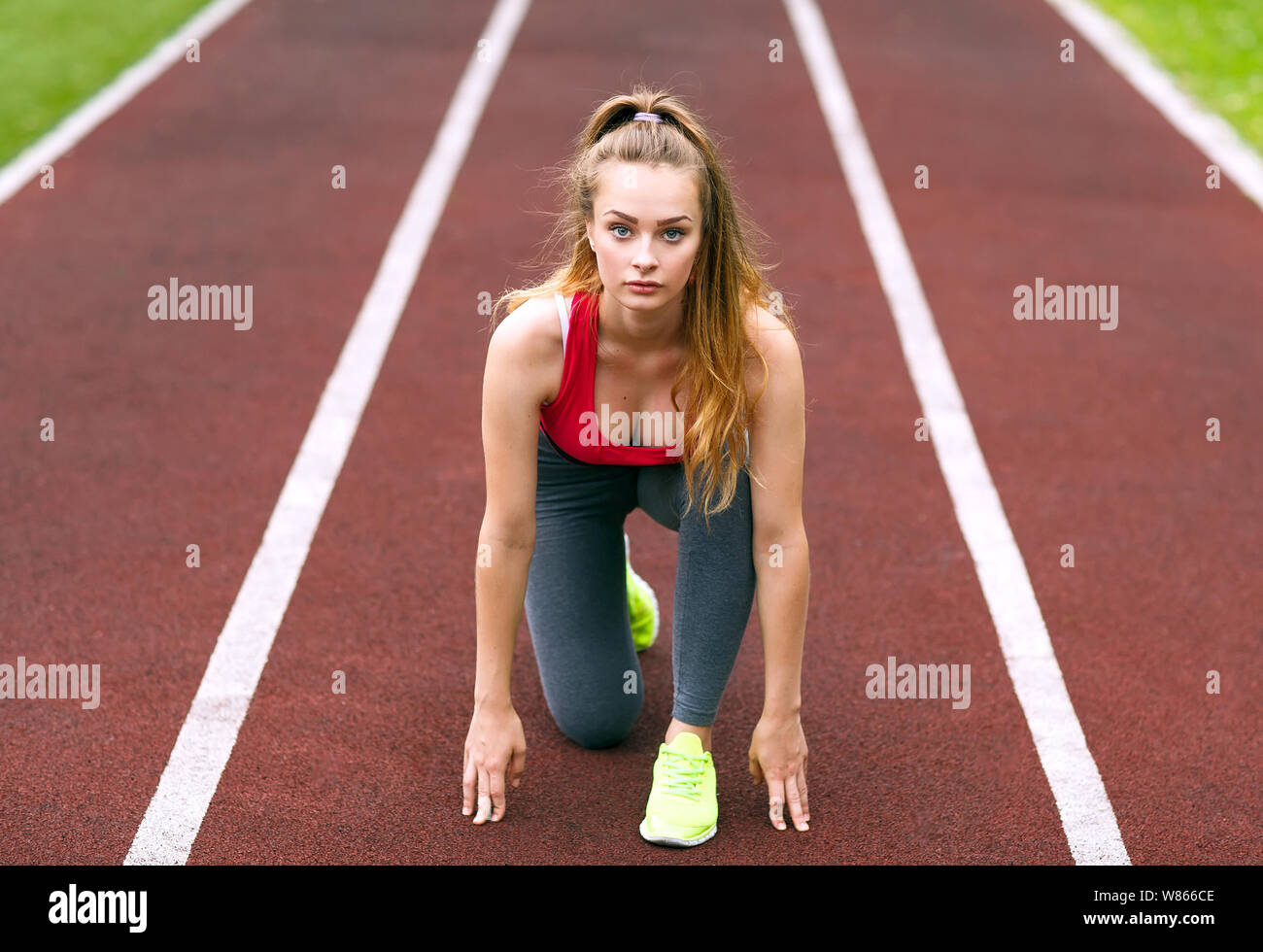 Beautiful athlete on a race track is ready to run Stock Photo - Alamy