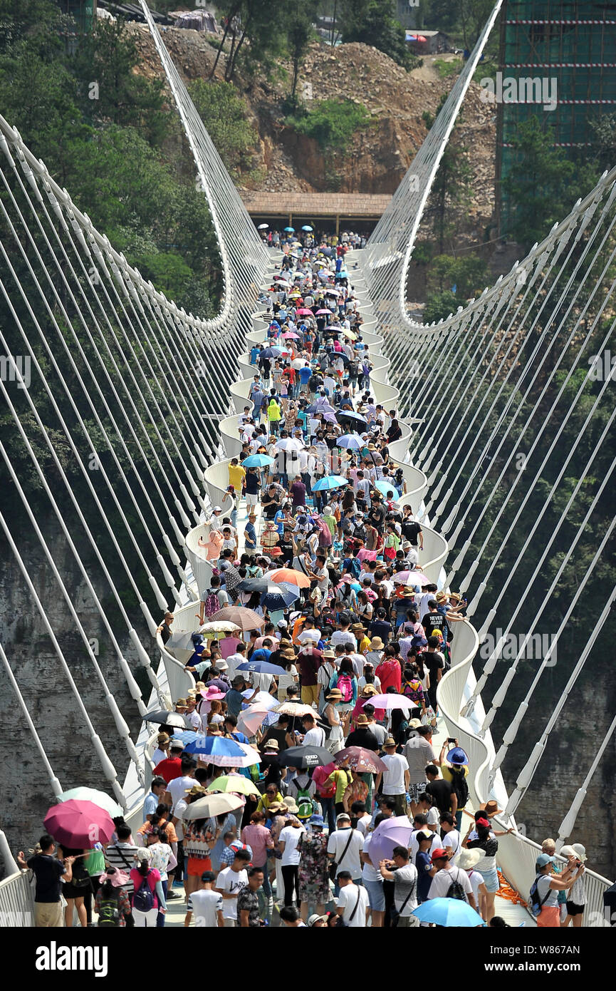 Tourists crowd the world's longest and highest glass-bottomed bridge ...