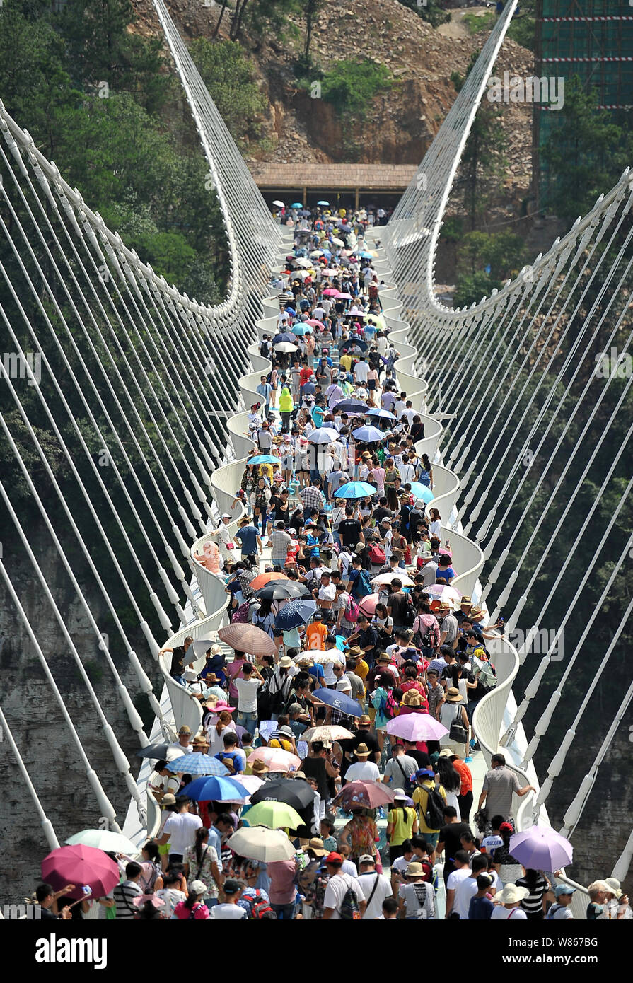 Tourists crowd the world's longest and highest glass-bottomed bridge ...
