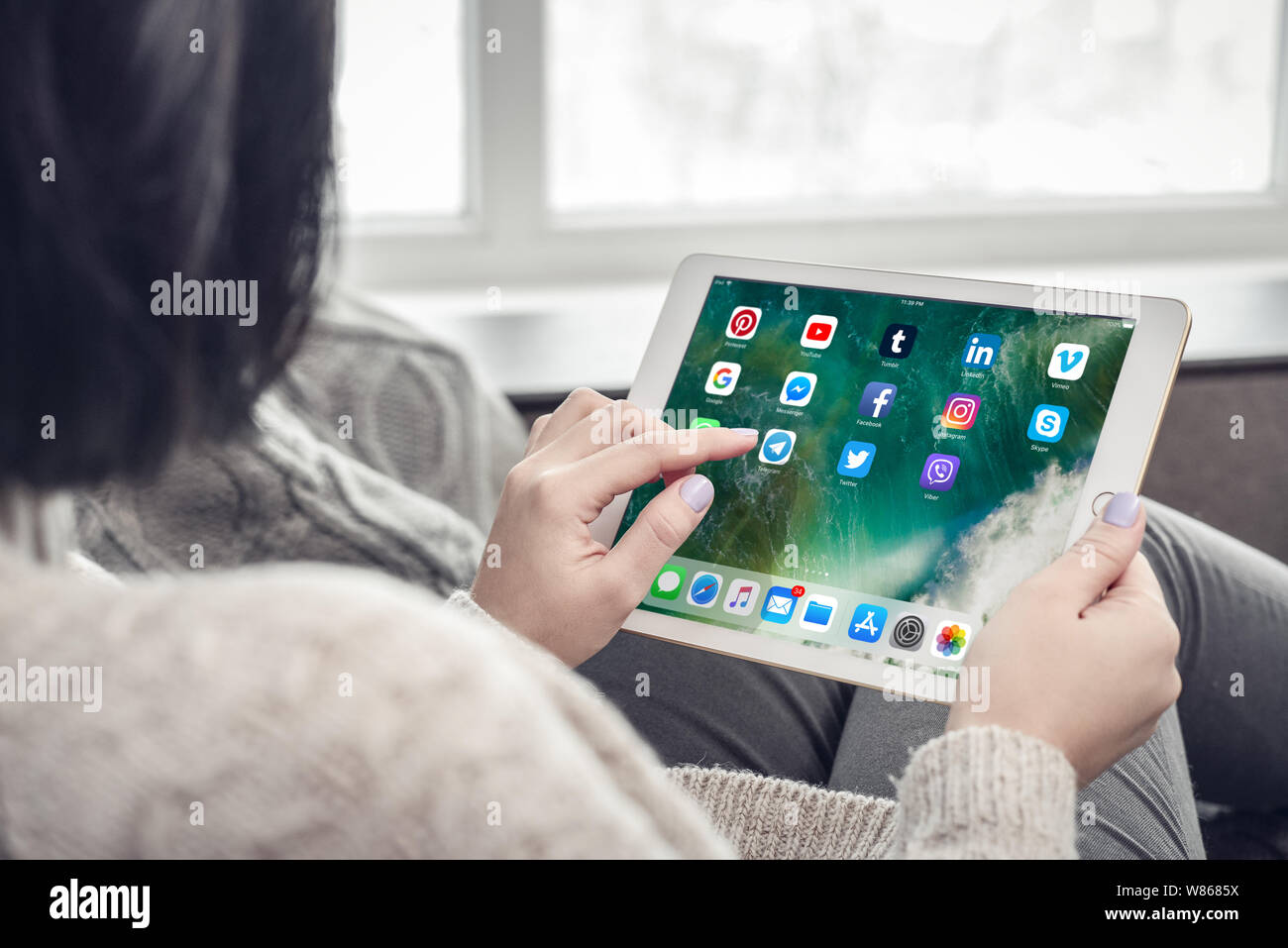 Kiev, Ukrain - February 10, 2018: Woman using social media apps on a ...