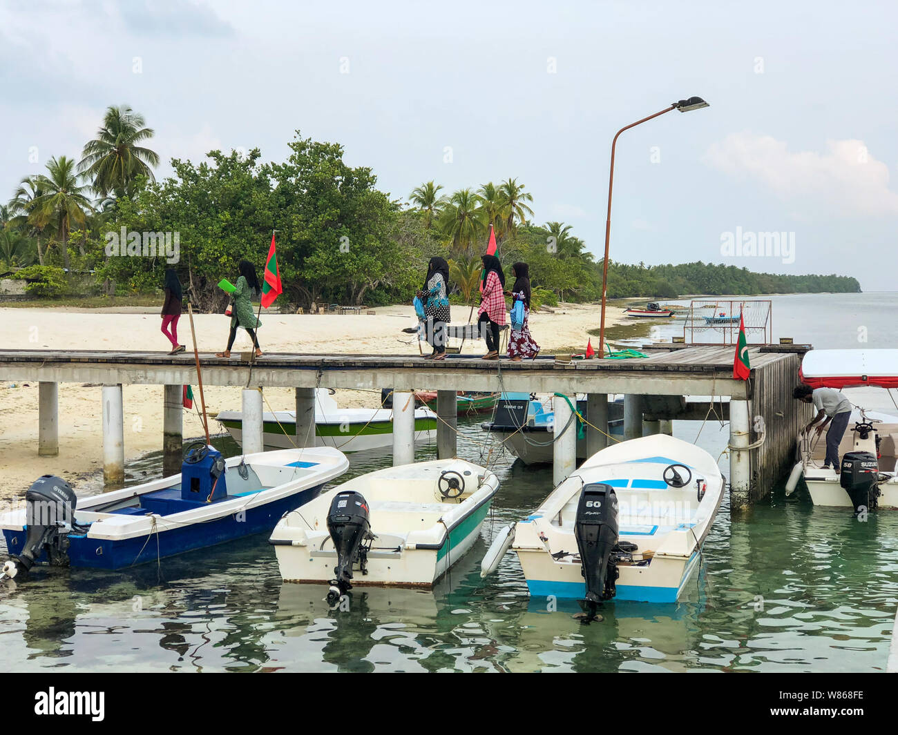 Fehendhoo island, Maldives - April 1, 2018: Pier with boats and local ...