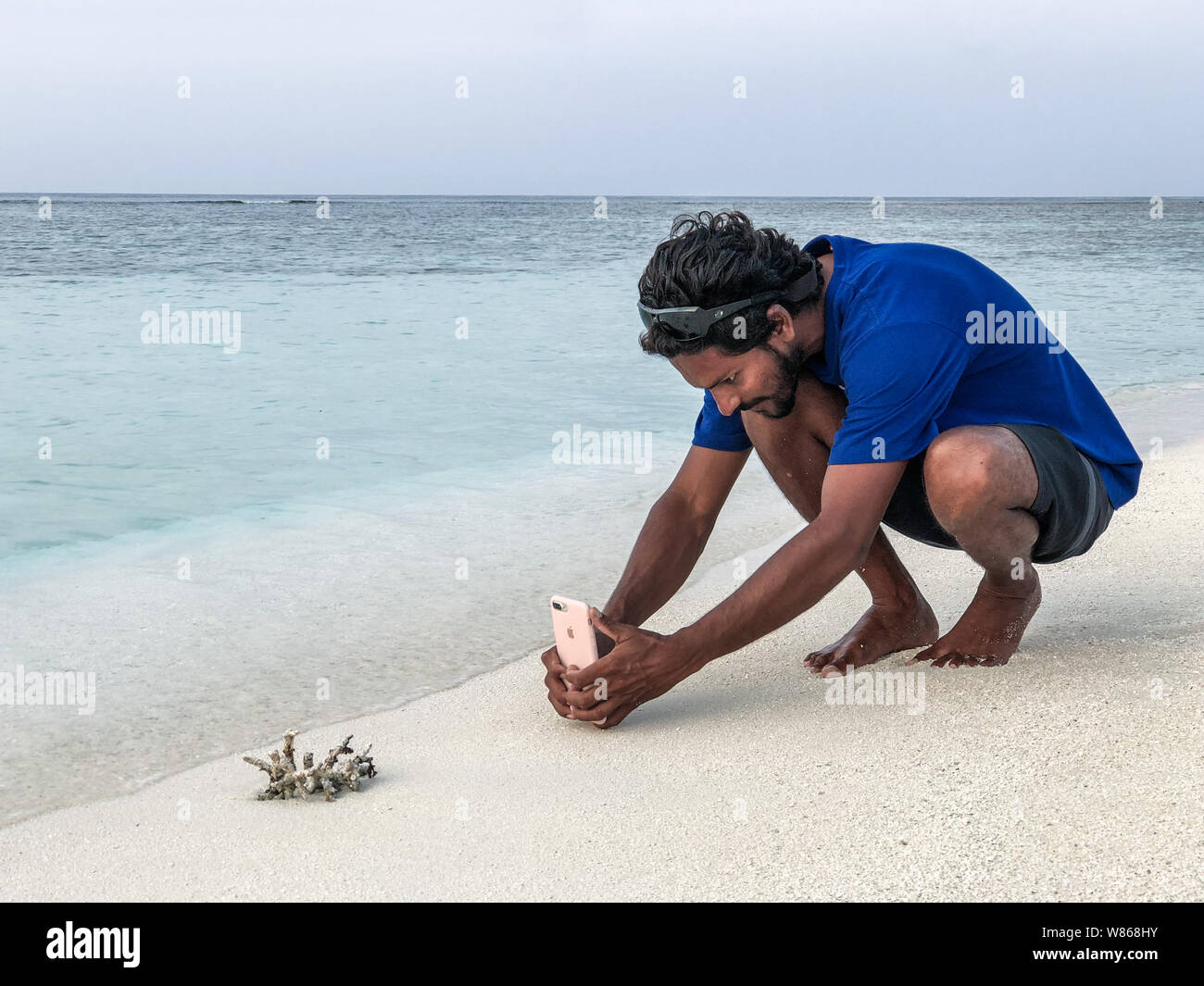 Fehendhoo island, Maldives - April 1, 2018: Maldivian man takes a ...