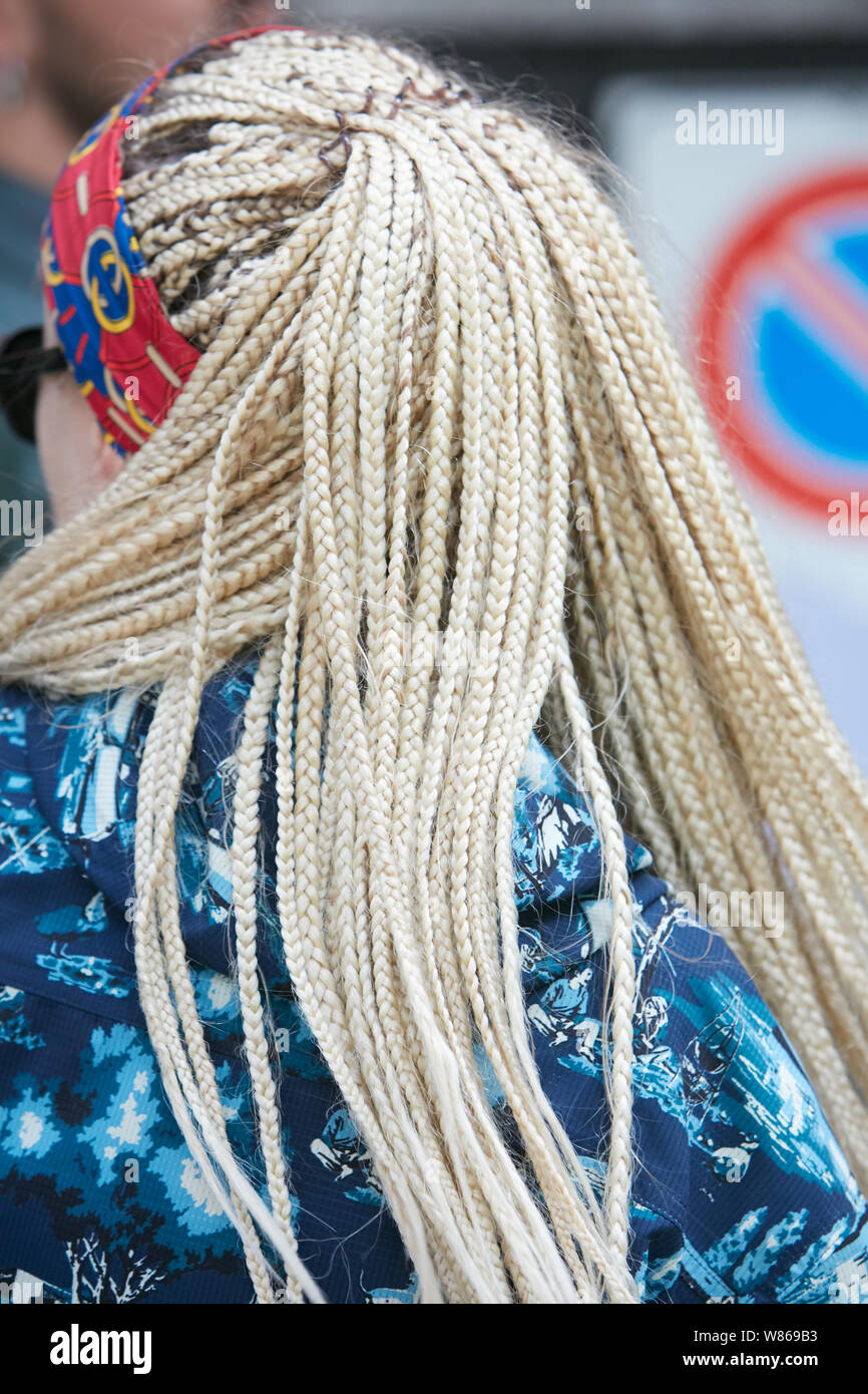 MILAN, ITALY - JUNE 15, 2019: Woman with blond braids and blue shirt ...