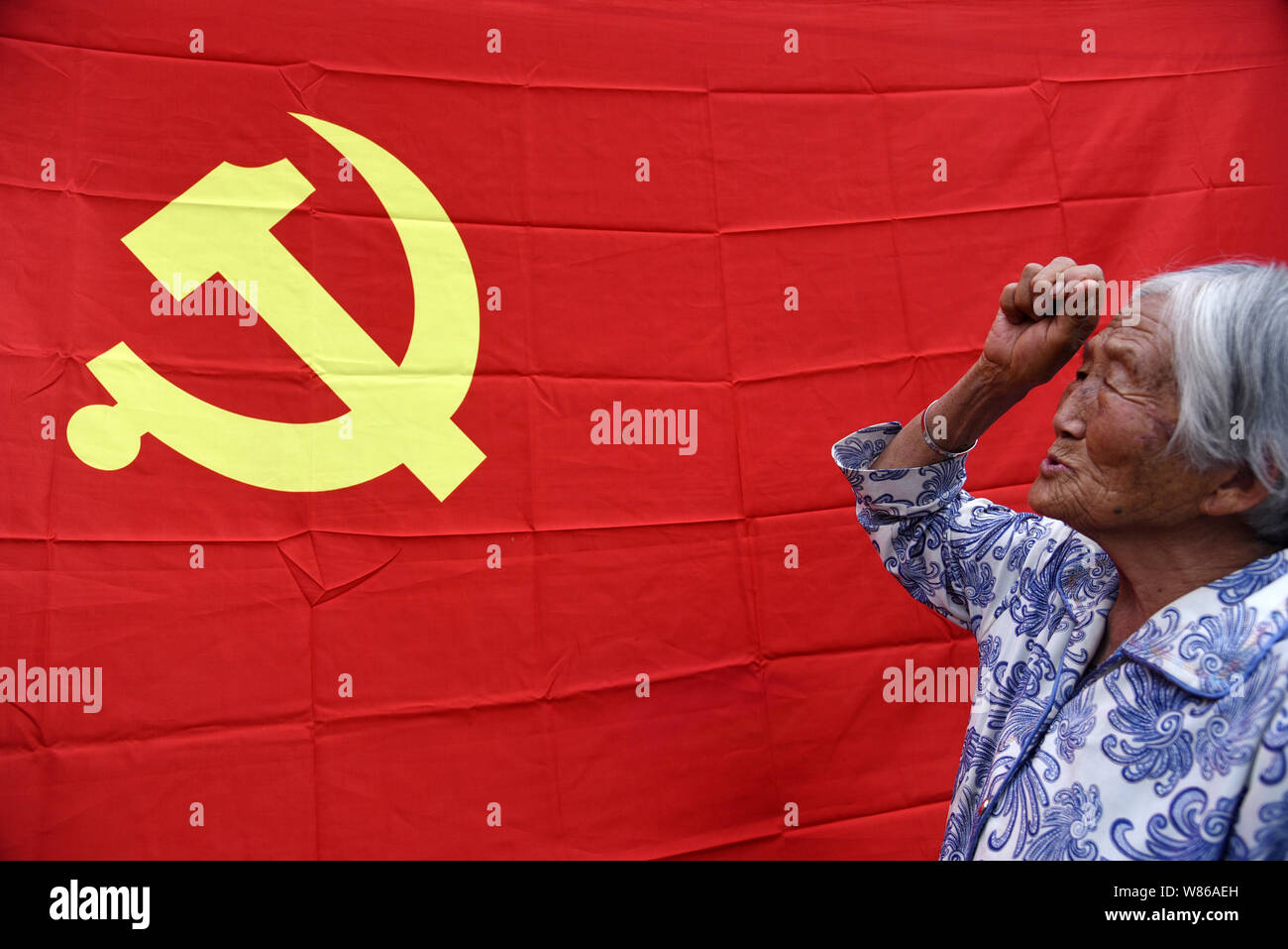 An elderly Chinese villager, also a member of the Communist Party of ...