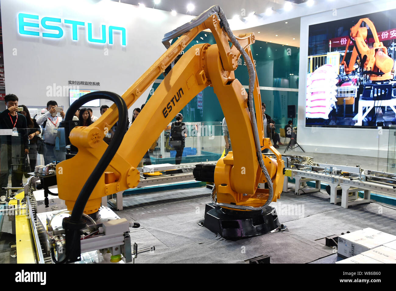 --FILE--A robot arm is on display at the stand of Estun Automation ...