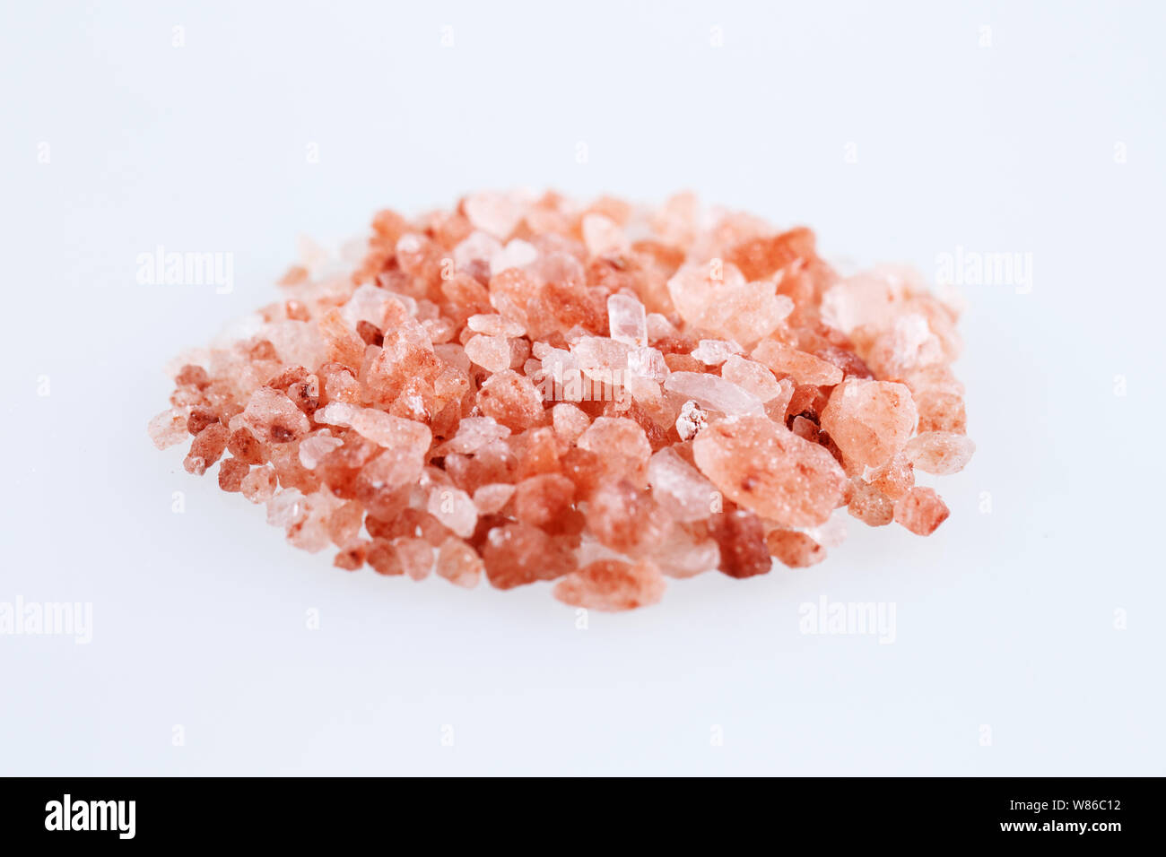 Pink himalayan salt isolated on white background Stock Photo - Alamy