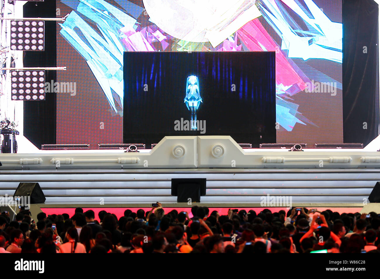 A Crowd Of Visitors Watch A Performance Of Hatsune Miku A Humanoid Persona Voiced By A Singing
