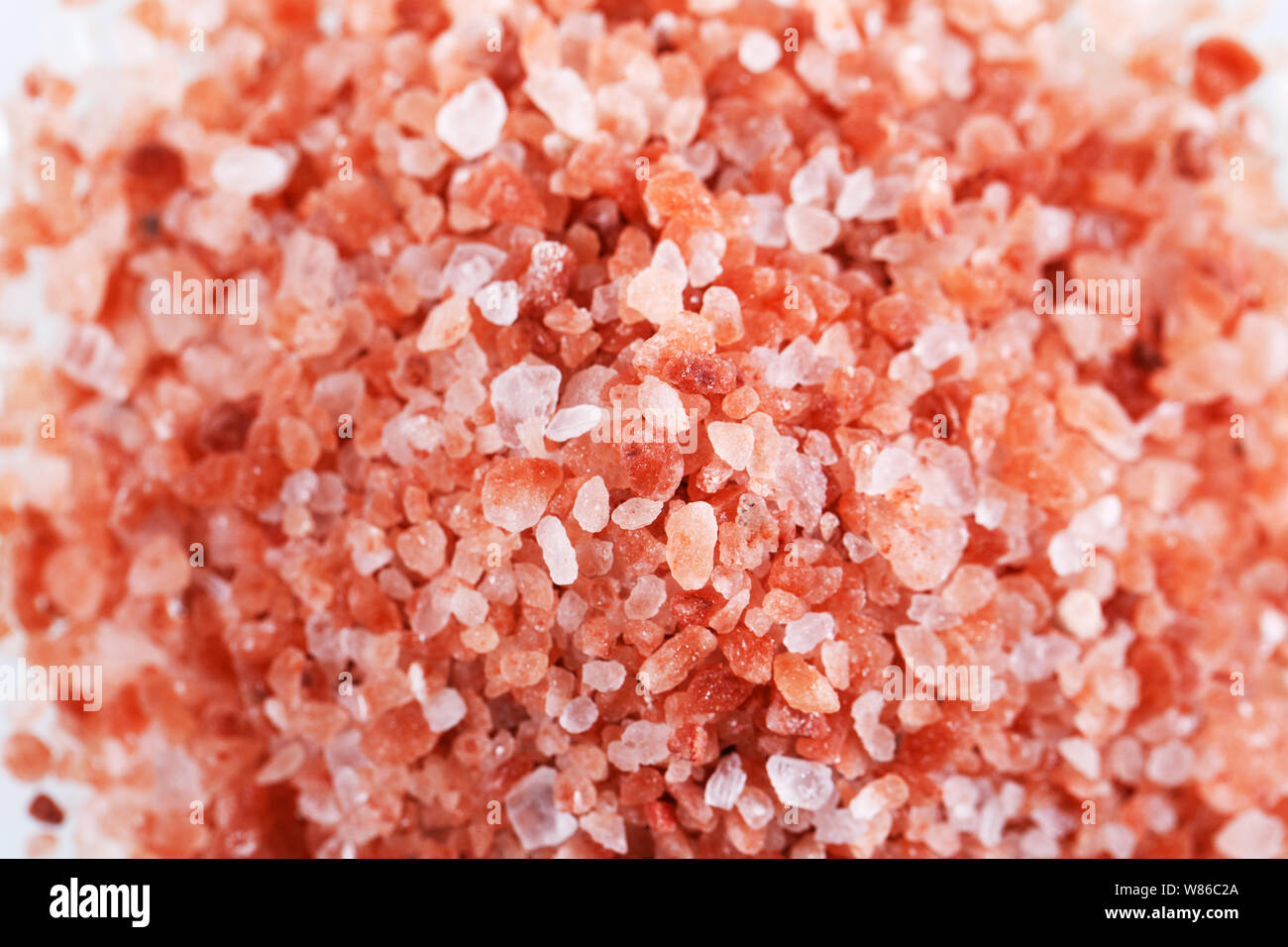 Pink himalayan salt isolated on white background Stock Photo - Alamy
