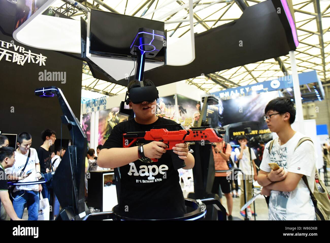 A visitor tries out a VR (Virtual Reality) device to play a electronic ...