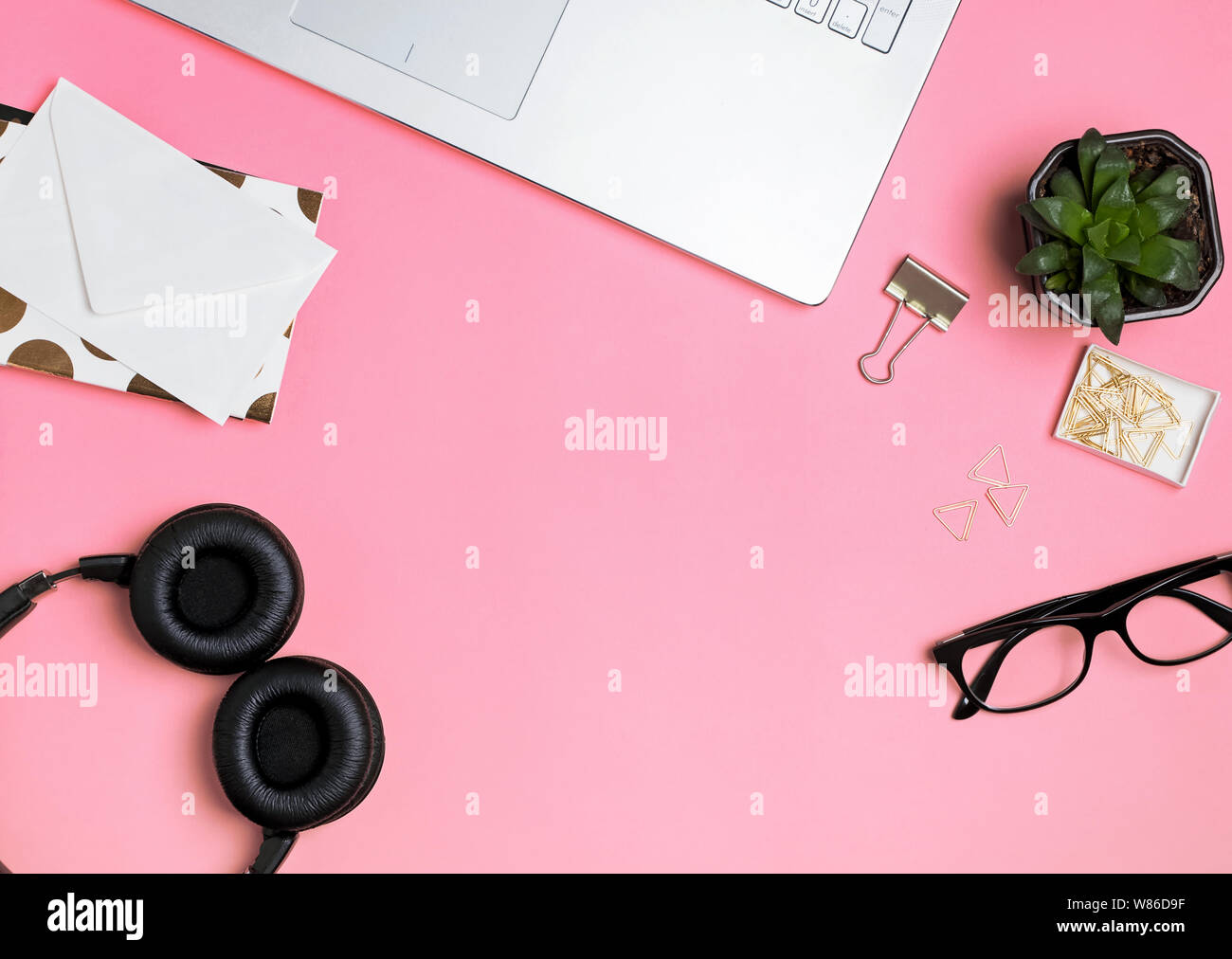 Modern workplace concept. Flat lay with earphones, laptop, glasses and ...