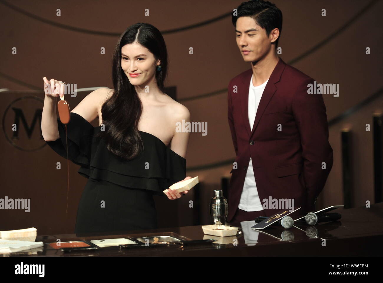 Chinese model and actress He Sui, left, makes her own ice cream next to ...