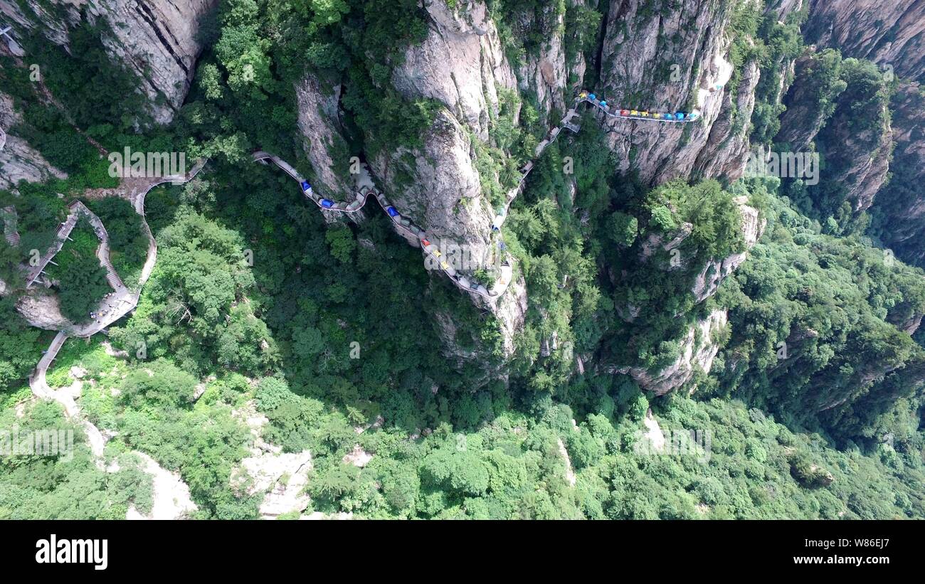 Aerial view of tents set up by backpackers on a walkway along the edge ...
