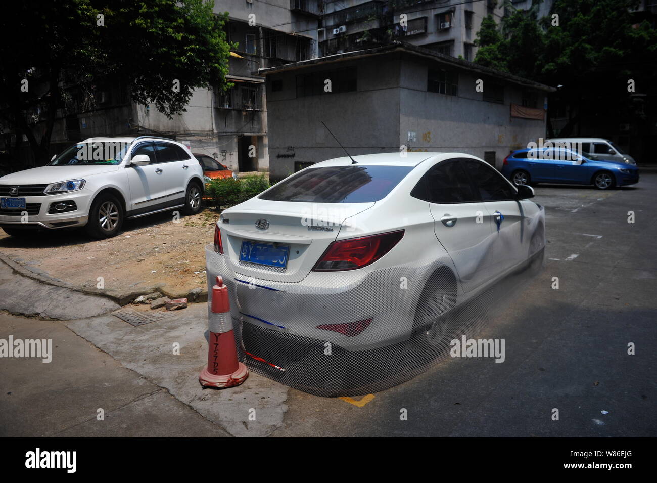 A car is encircled by a steel netting to prevent mice from invasion at ...