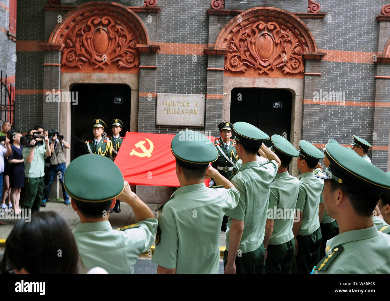Chinese paramilitary policemen swear in before a flag of the Communist ...