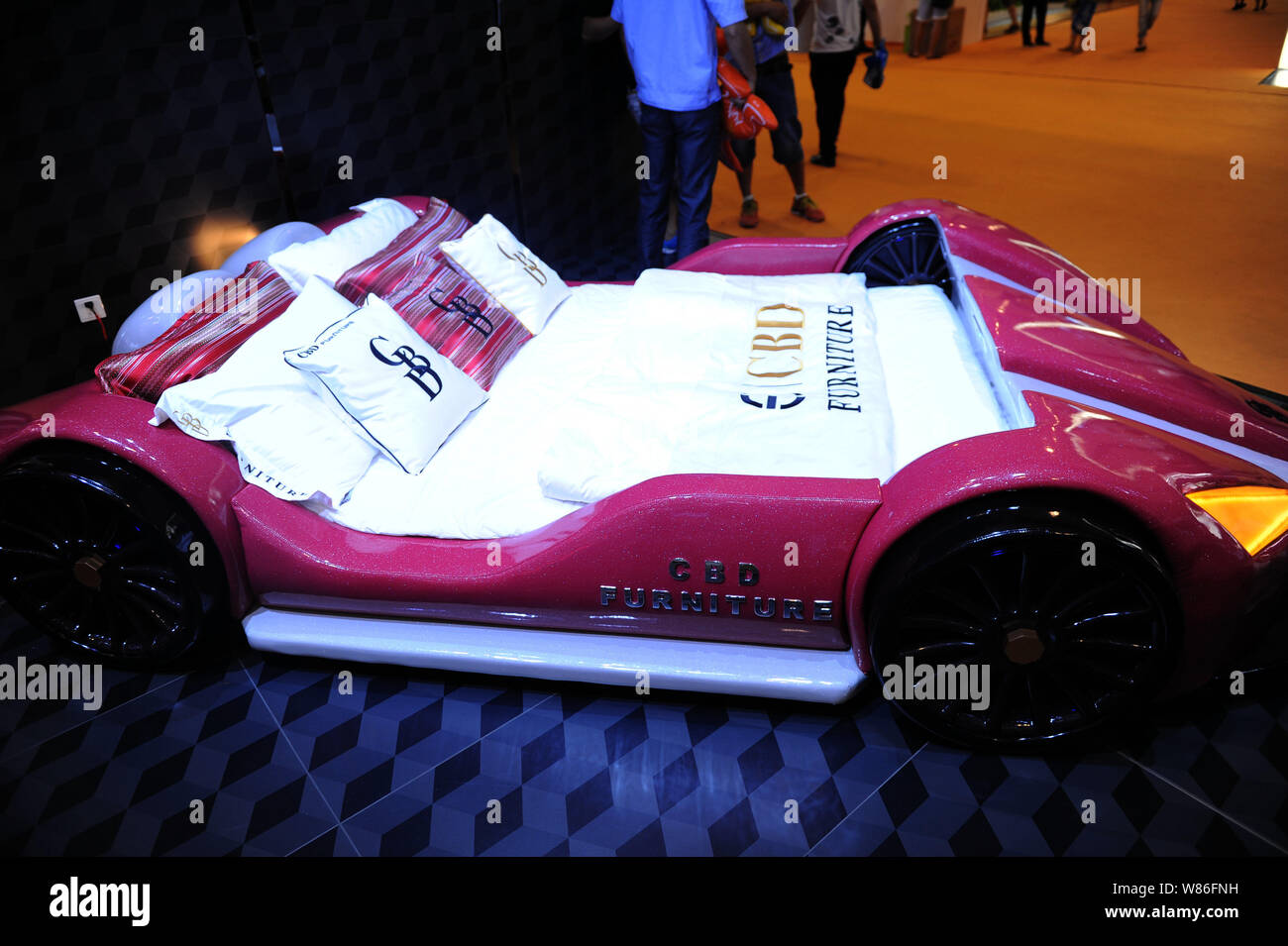 A bed resembling a Ferrari sports car is on display at the 17th ...