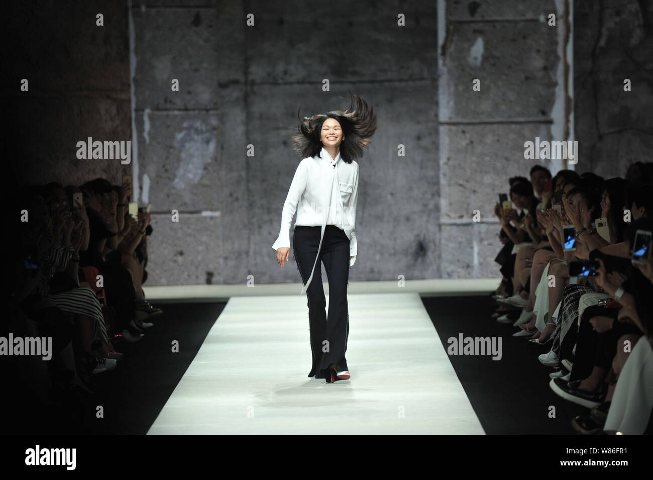 Chinese fashion designer Lv Yan or Lu Yan greets guests at a fashion ...