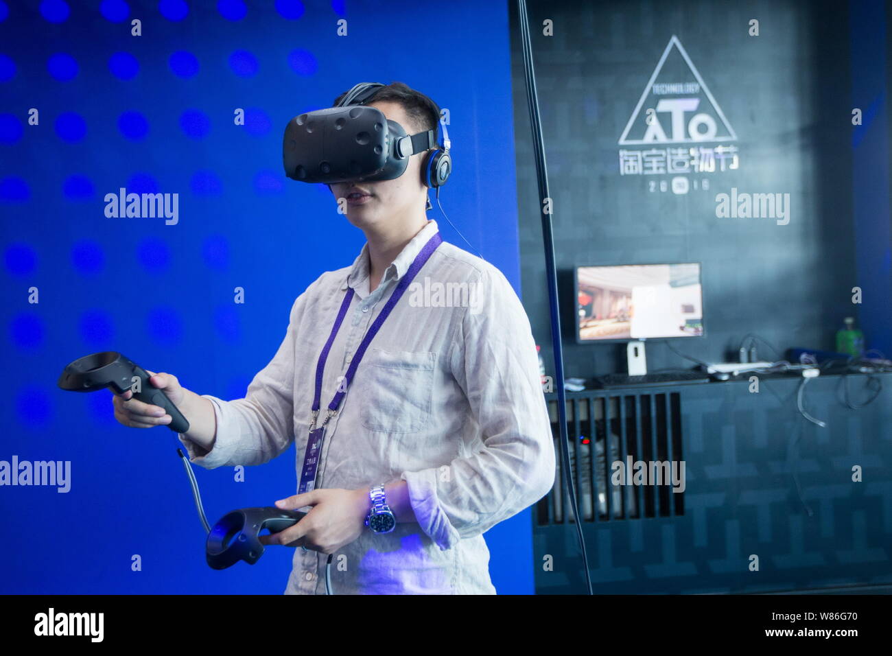 A visitor tries out a VR (Virtual Reality) device of HTC for virtual ...