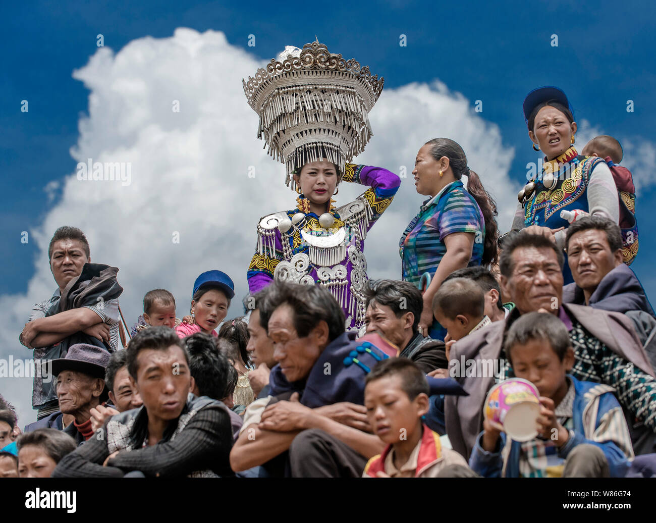 A Chines woman of Yi ethnical minority dressed in a traditional costume ...