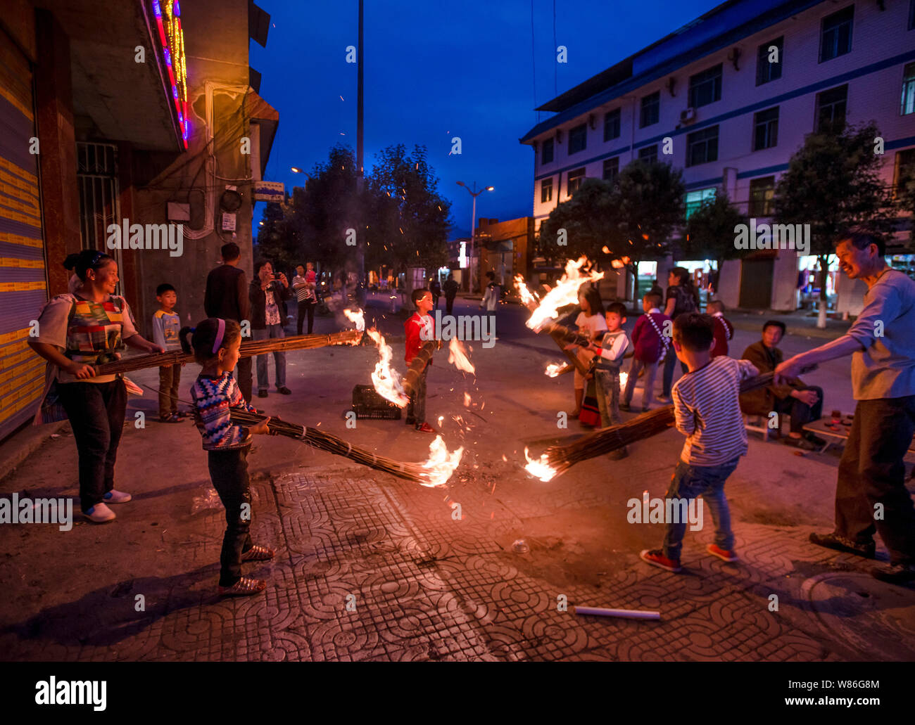 Visitors and people of Yi ethnical minority celebrate the Torch ...