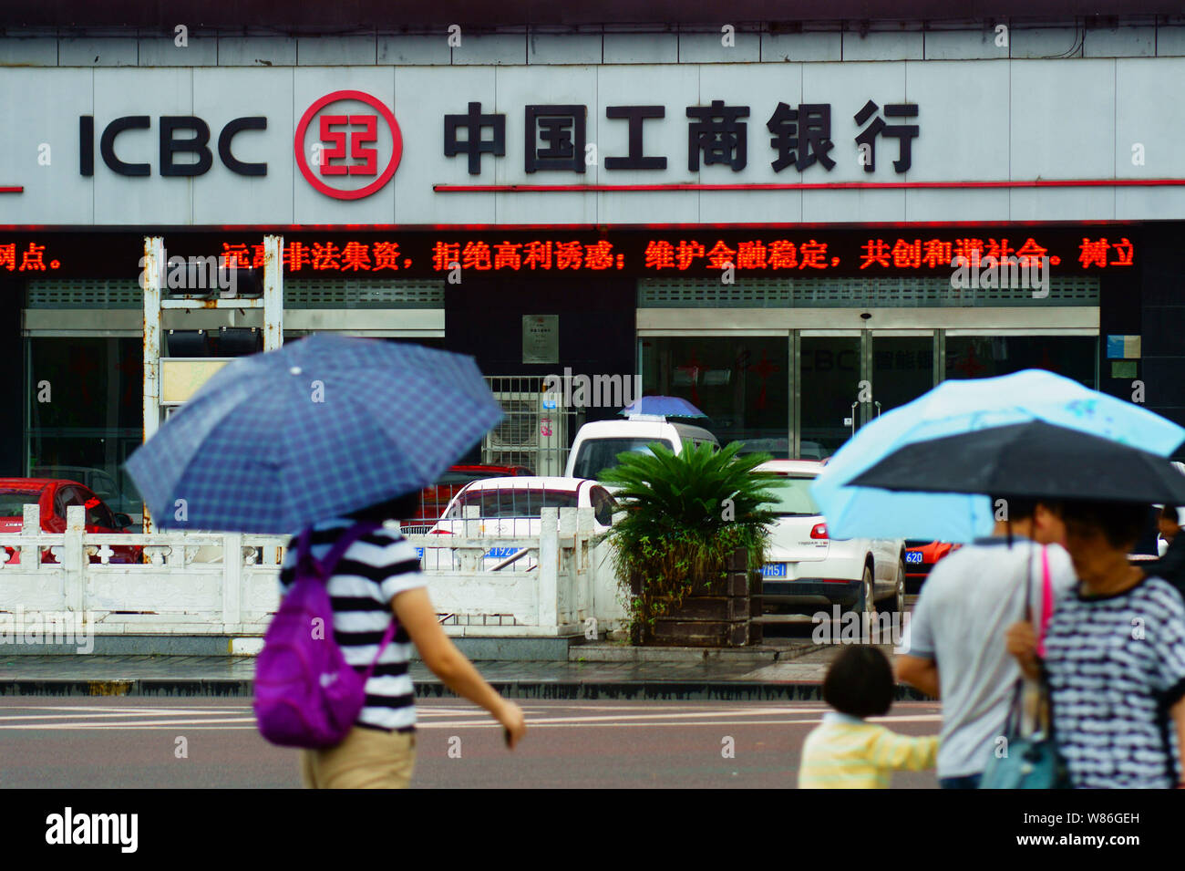 Pedestrians walk past a branch of ICBC (Industrial and Commercial Bank ...