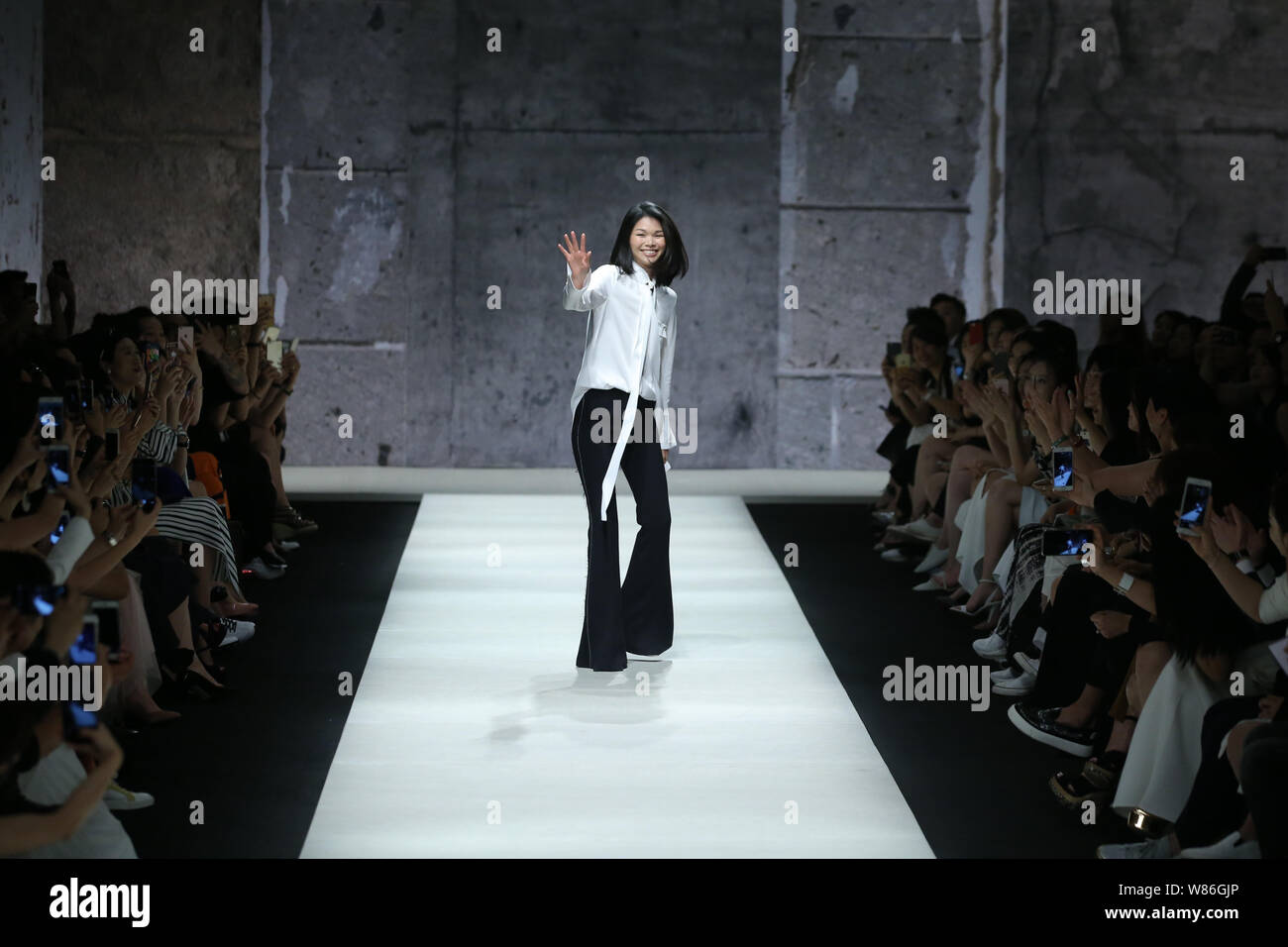 Chinese fashion designer Lv Yan or Lu Yan greets guests at a fashion ...