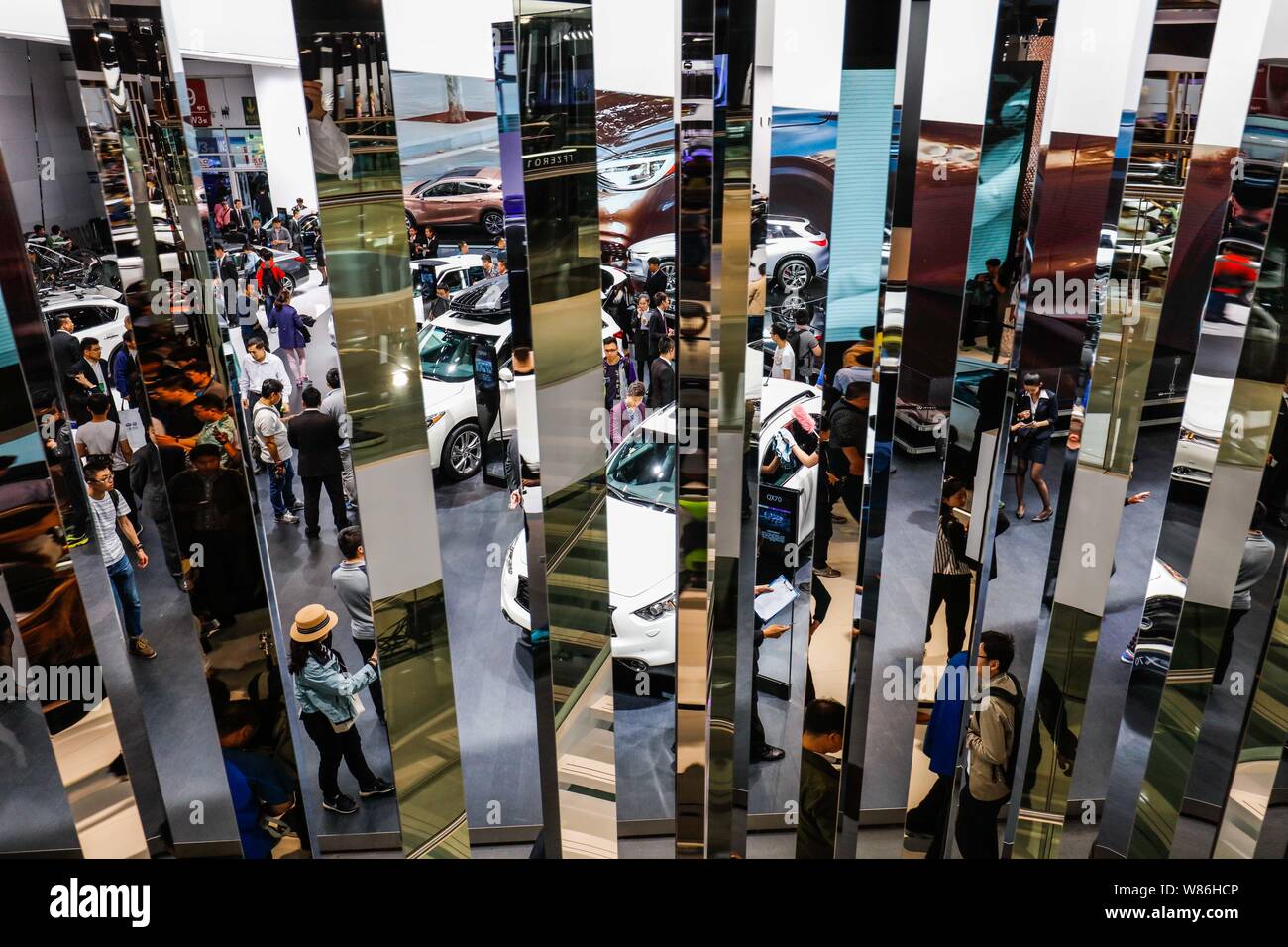 --FILE--Chinese visitors look at cars on display during the 14th ...