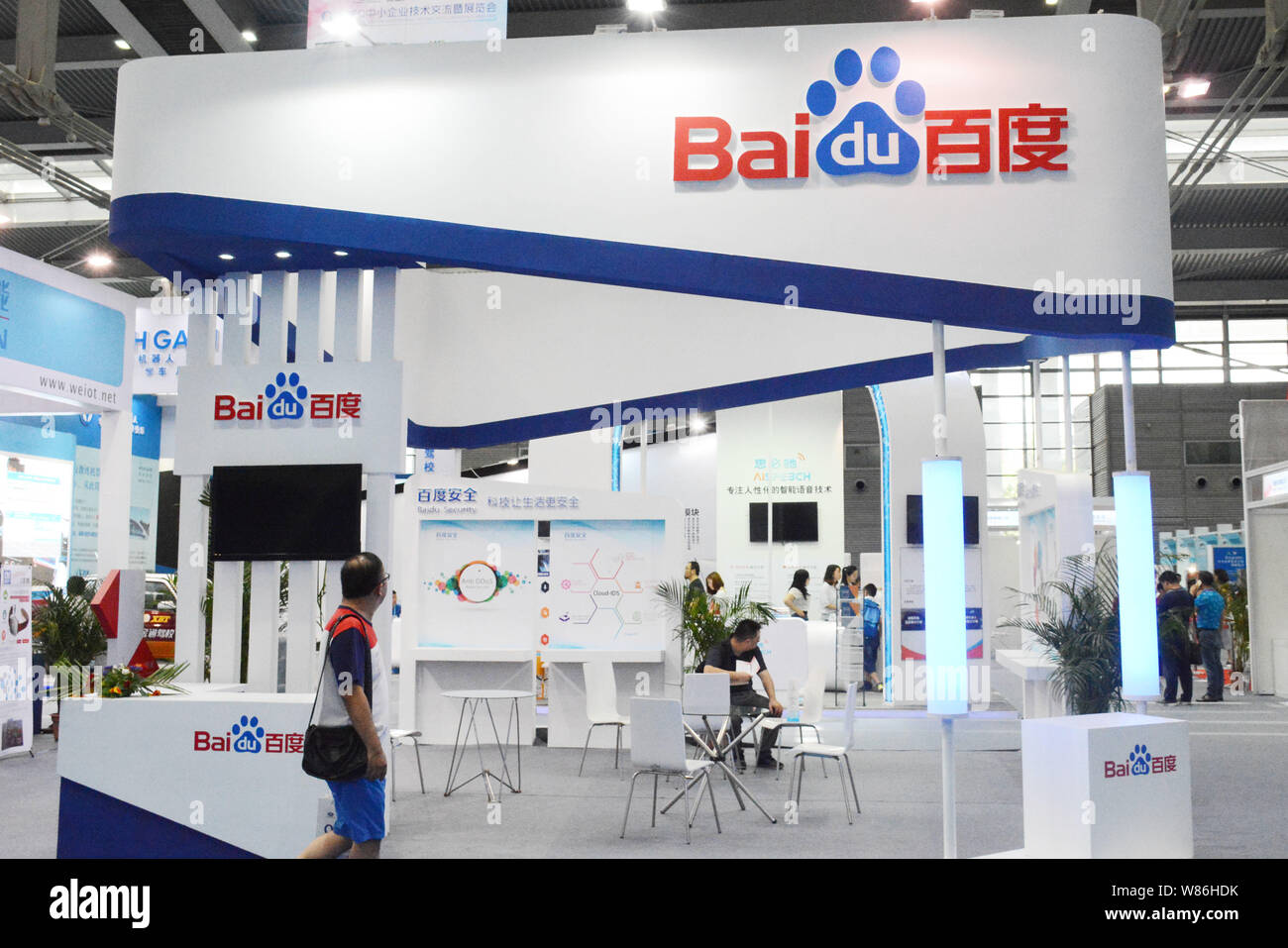 A visitor walks past the stand of Baidu during an exhibition in ...