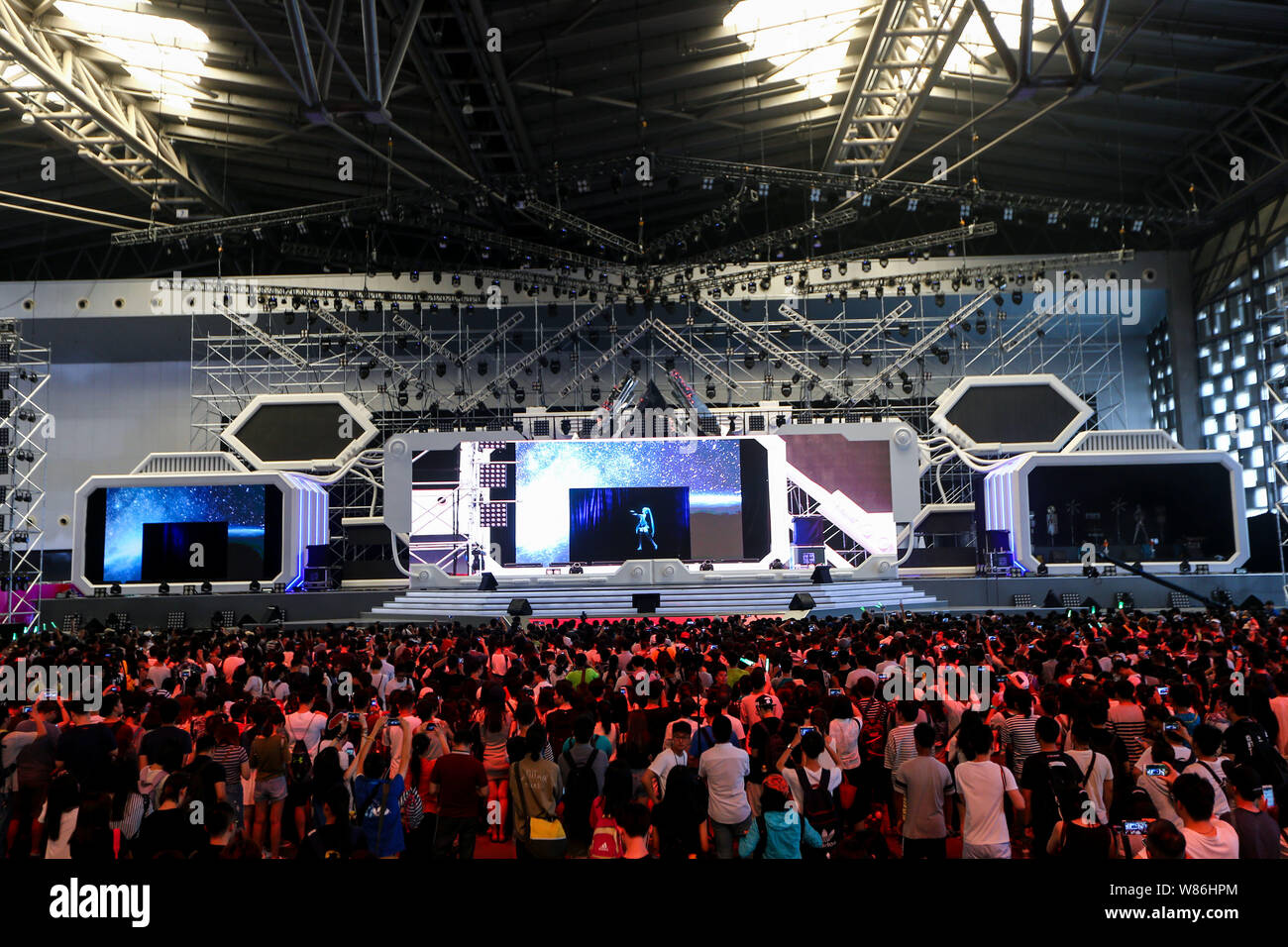 A Crowd Of Visitors Watch A Performance Of Hatsune Miku A Humanoid Persona Voiced By A Singing 