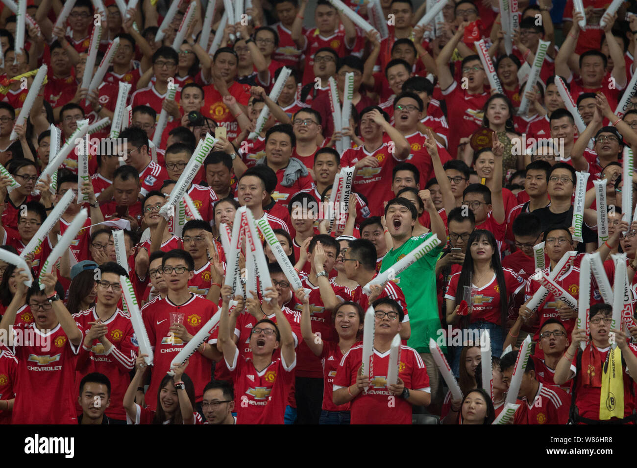 Chinese football fans shout slogans to show support for Manchester ...