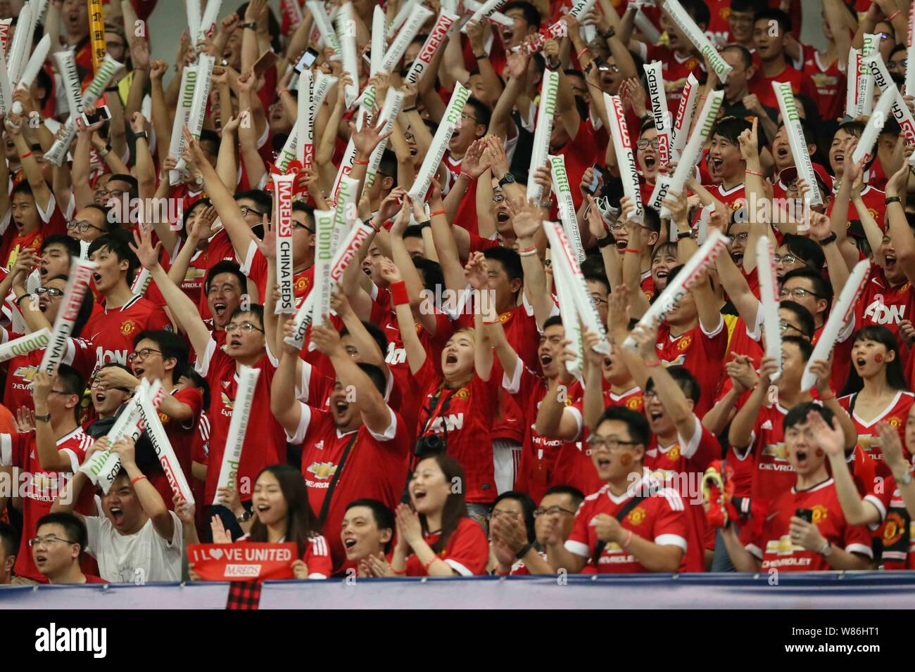 Chinese football fans shout slogans to show support for Manchester ...