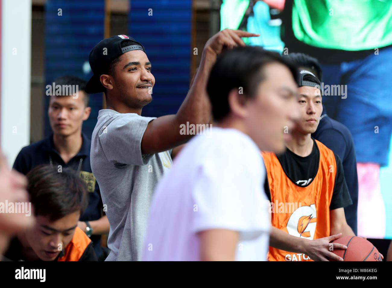 NBA player Gary Harris, center, attends the opening game of the ...