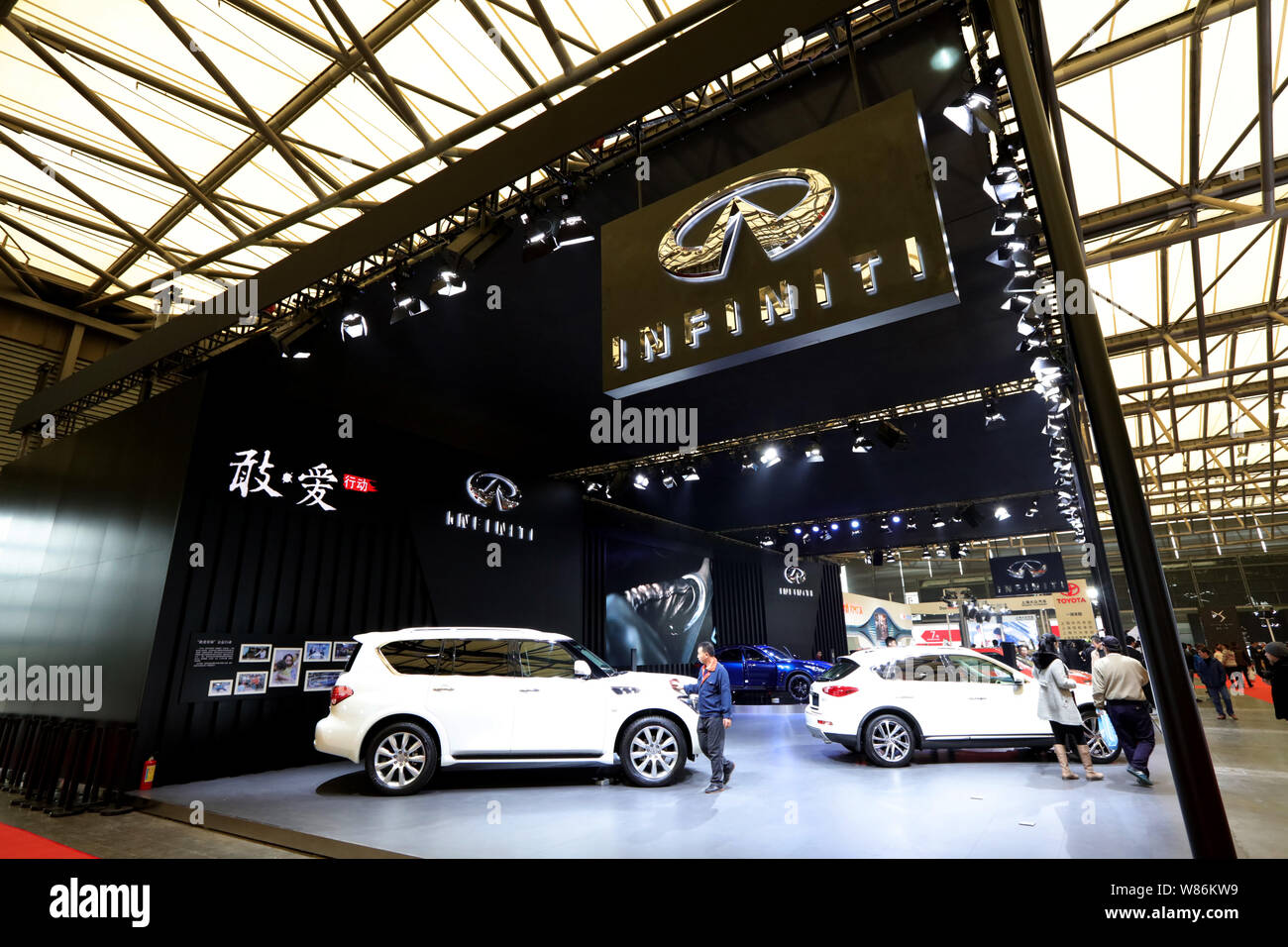 --FILE--Visitors look at Infiniti cars on display during an auto show ...