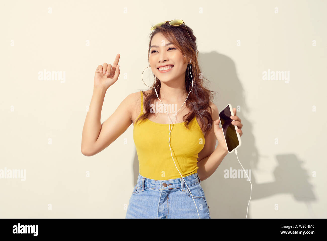 Summer lady. Beautiful asian girl singing and dancing while listening ...