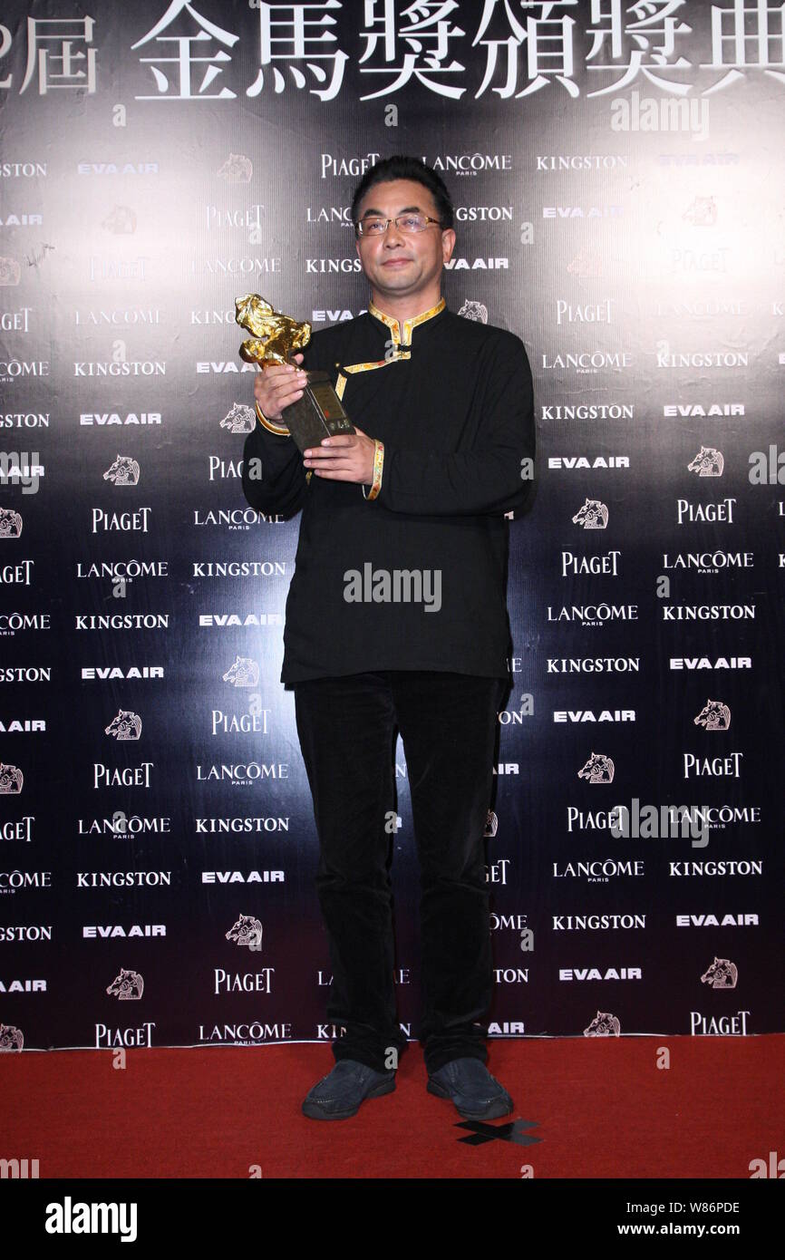 --FILE--Chinese Tibetan film director Pema Tseden poses with the trophy of the Best Adapted ...