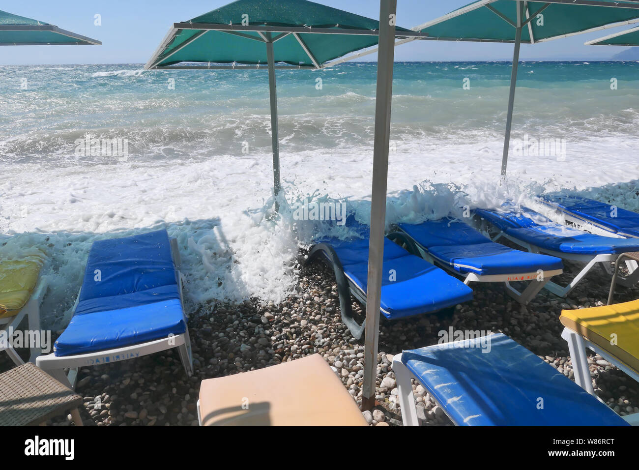 Windy beach with white umbrellas hi-res stock photography and images ...