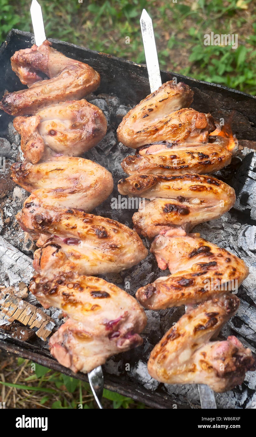 Grilled chicken wing kebabs ready to eat Stock Photo - Alamy