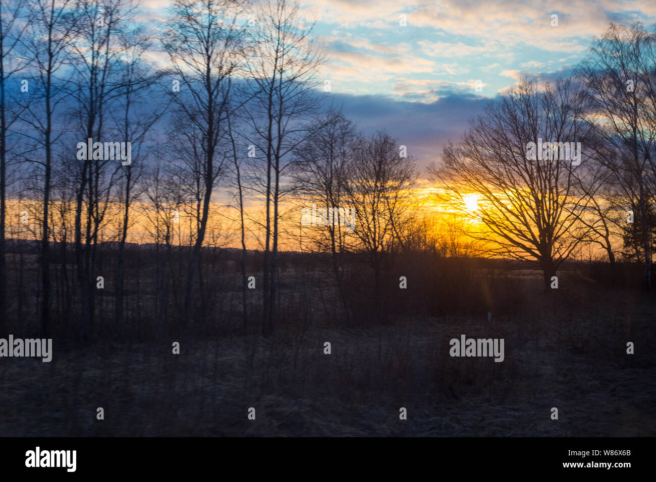 Train window view with dramatic sunset light Stock Photo - Alamy