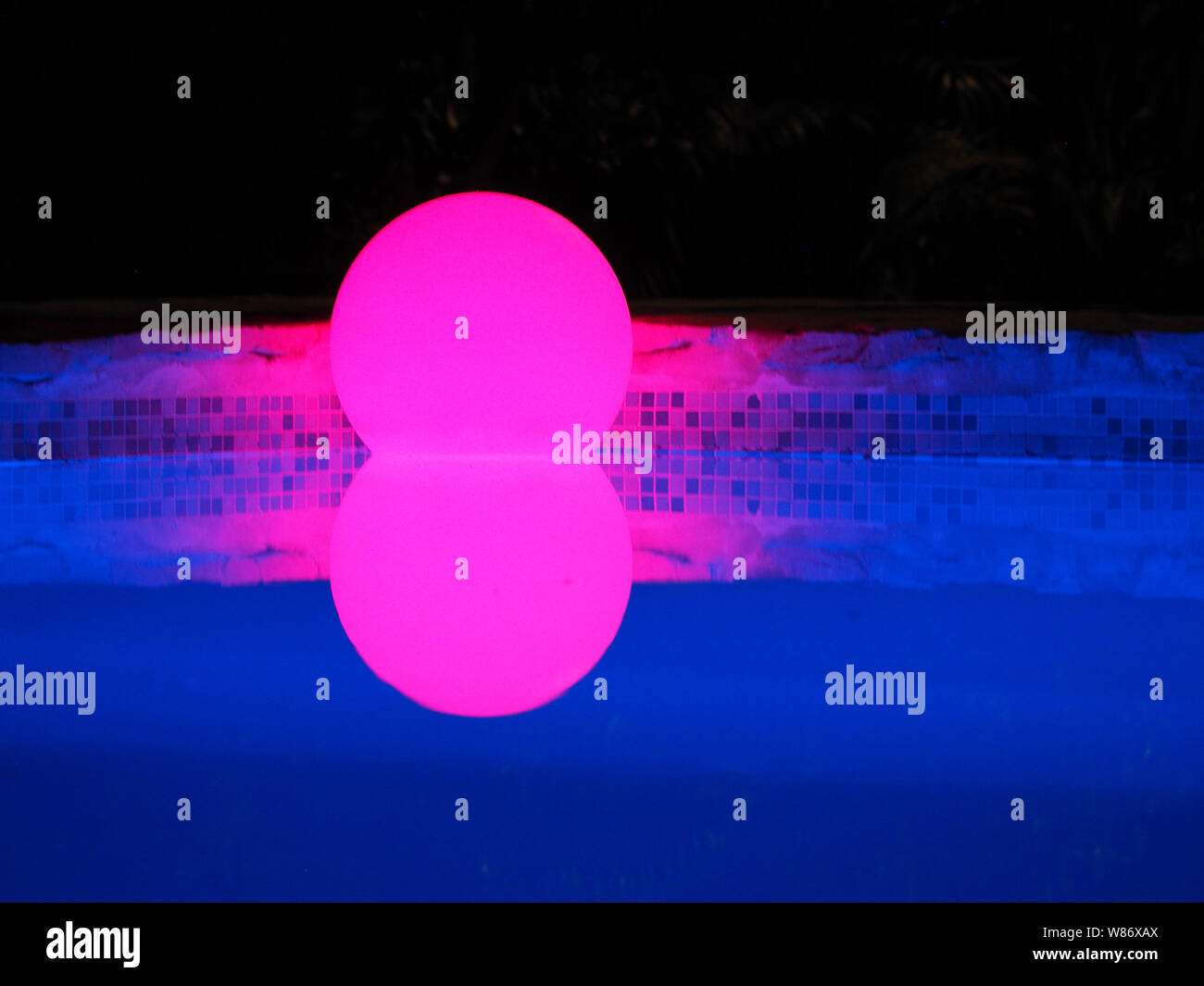 Glowing ball at night in pink color in the swimming pool Stock Photo ...